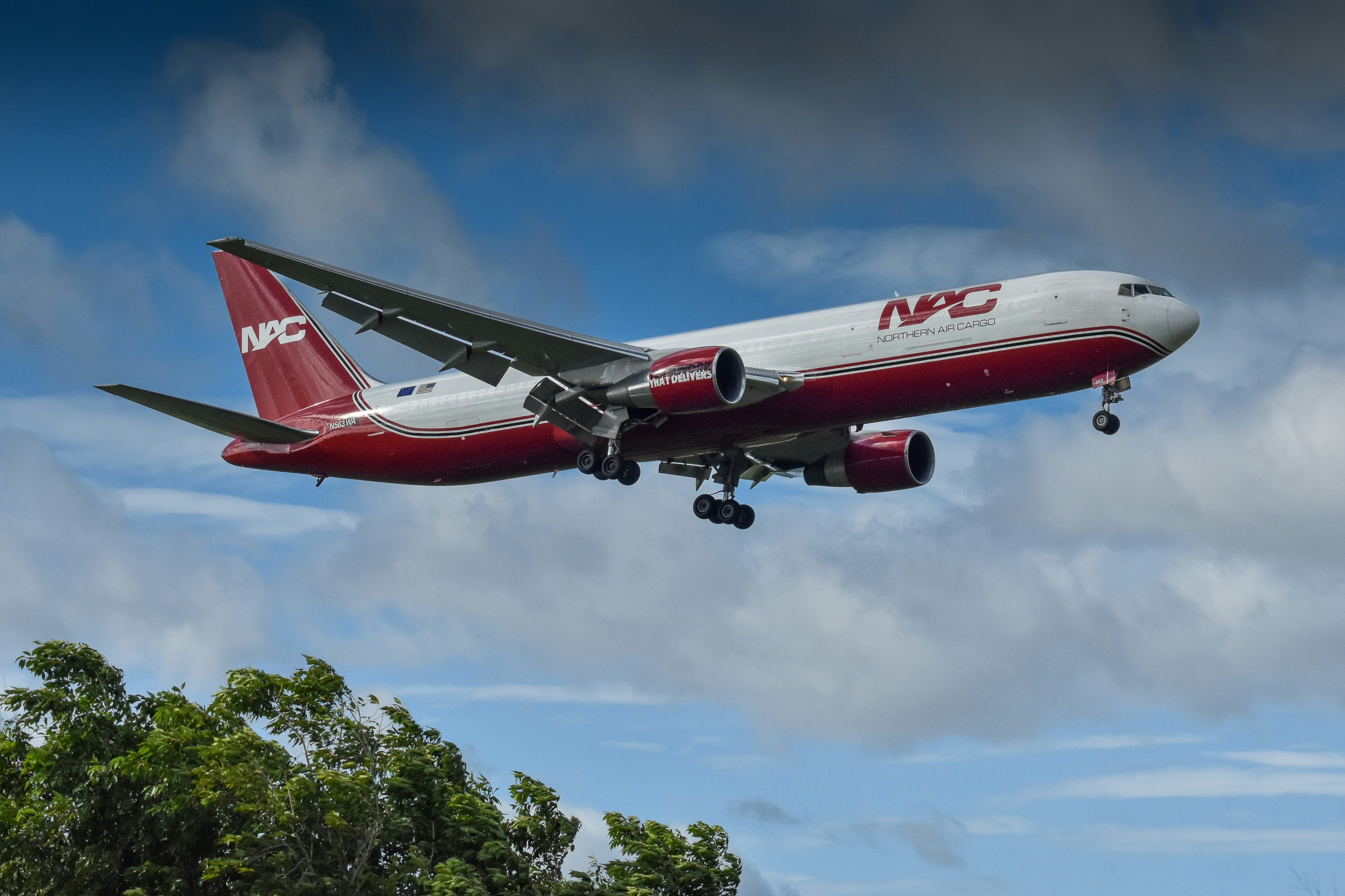 A large airplane flying in the sky photo – Free Piarco Image on Unsplash