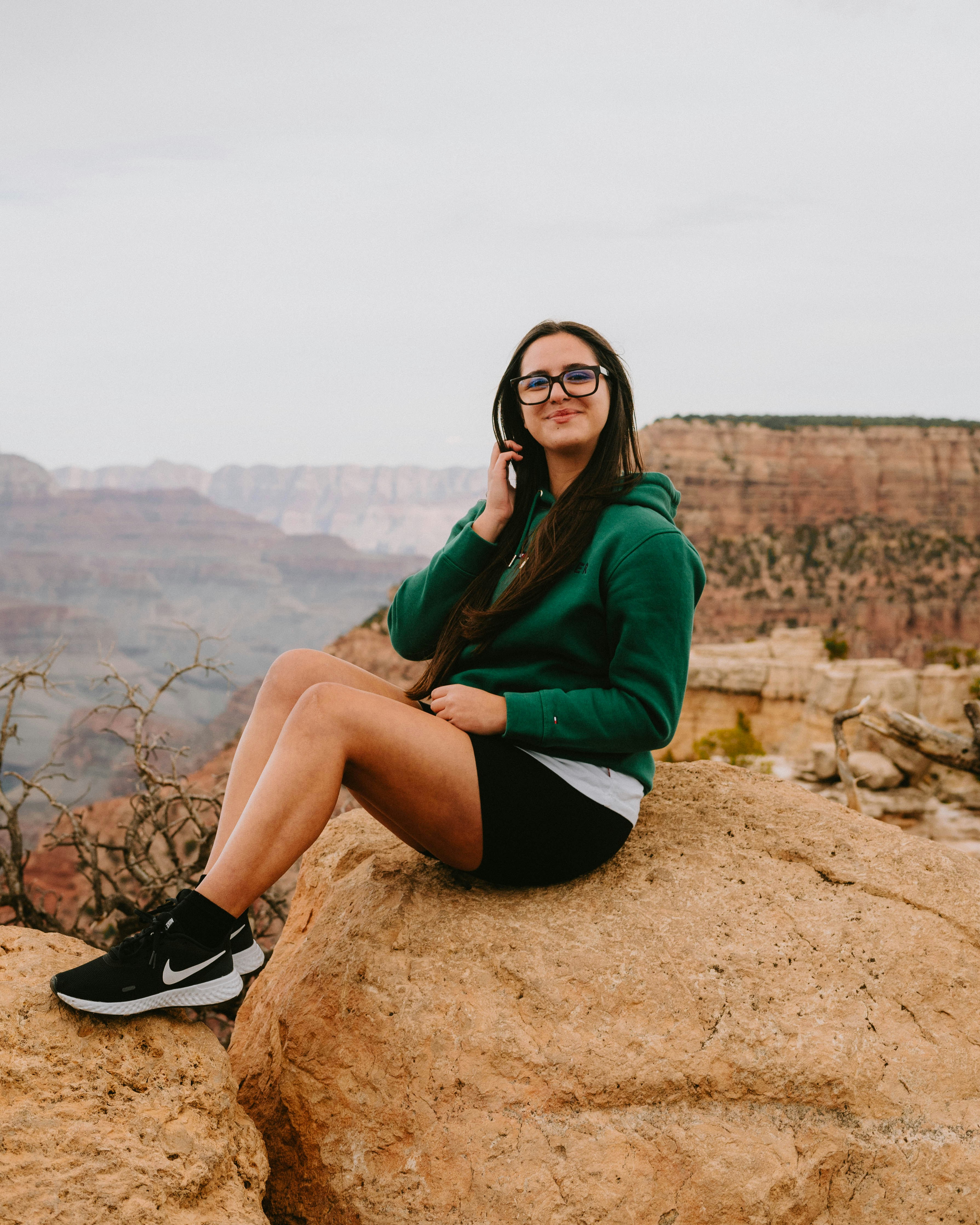 Green Hoodie, Canyon Backdrop: A Quiet Moment on the Edge