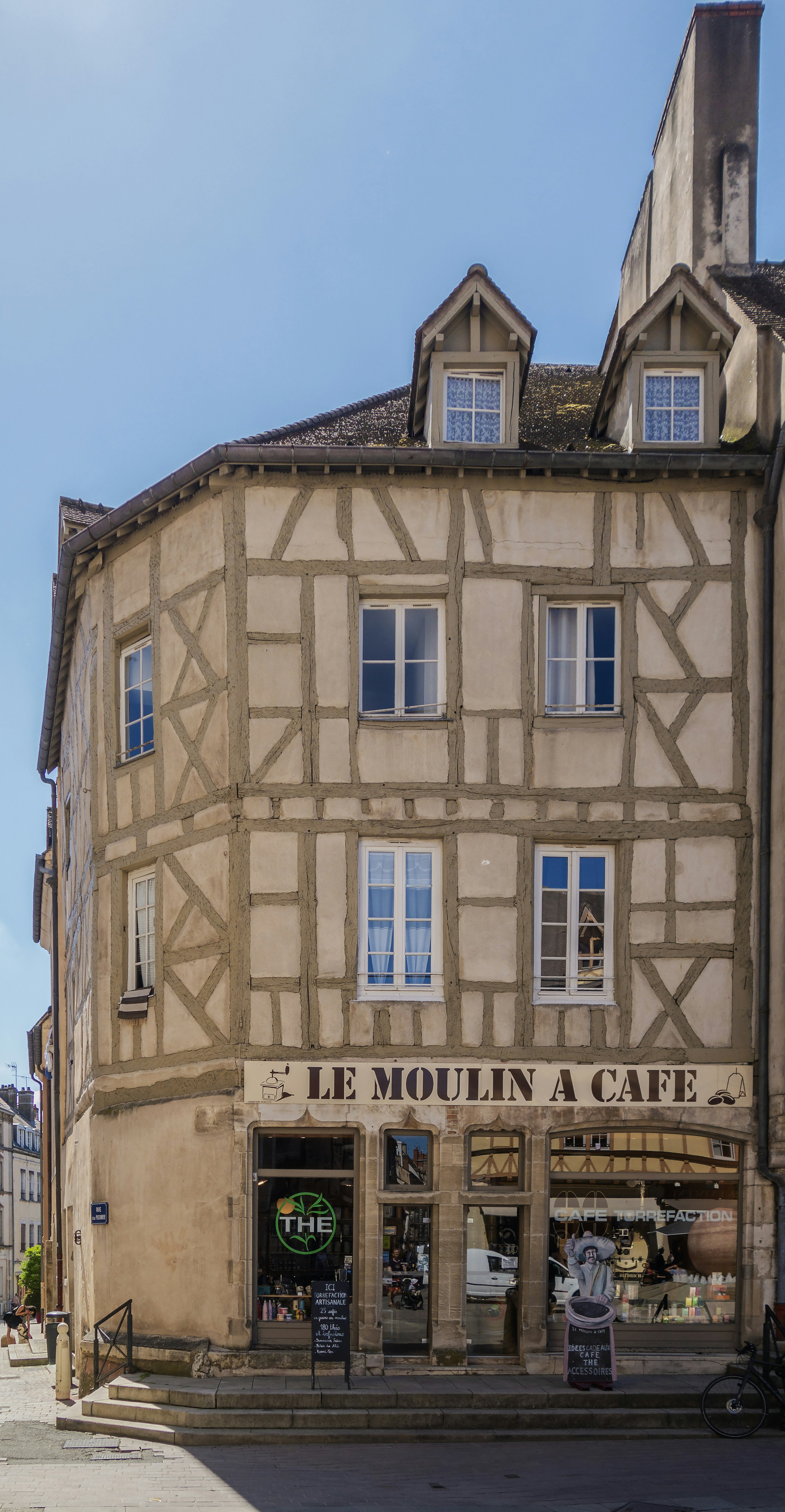 Timber-Framed Café Facade on a Sunlit French Street