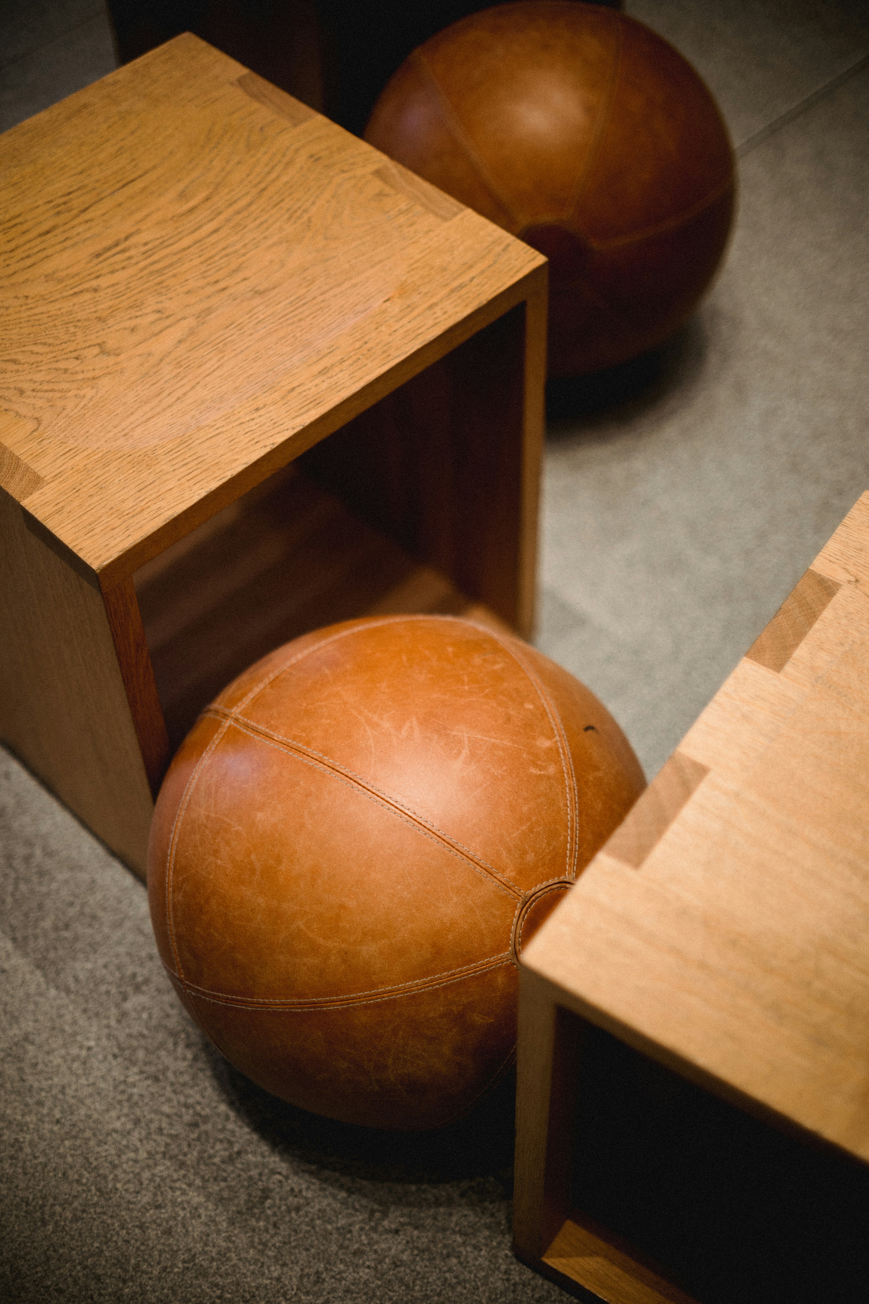 Leather Orbs Between Wooden Cubes: A Quiet Studio Still Life