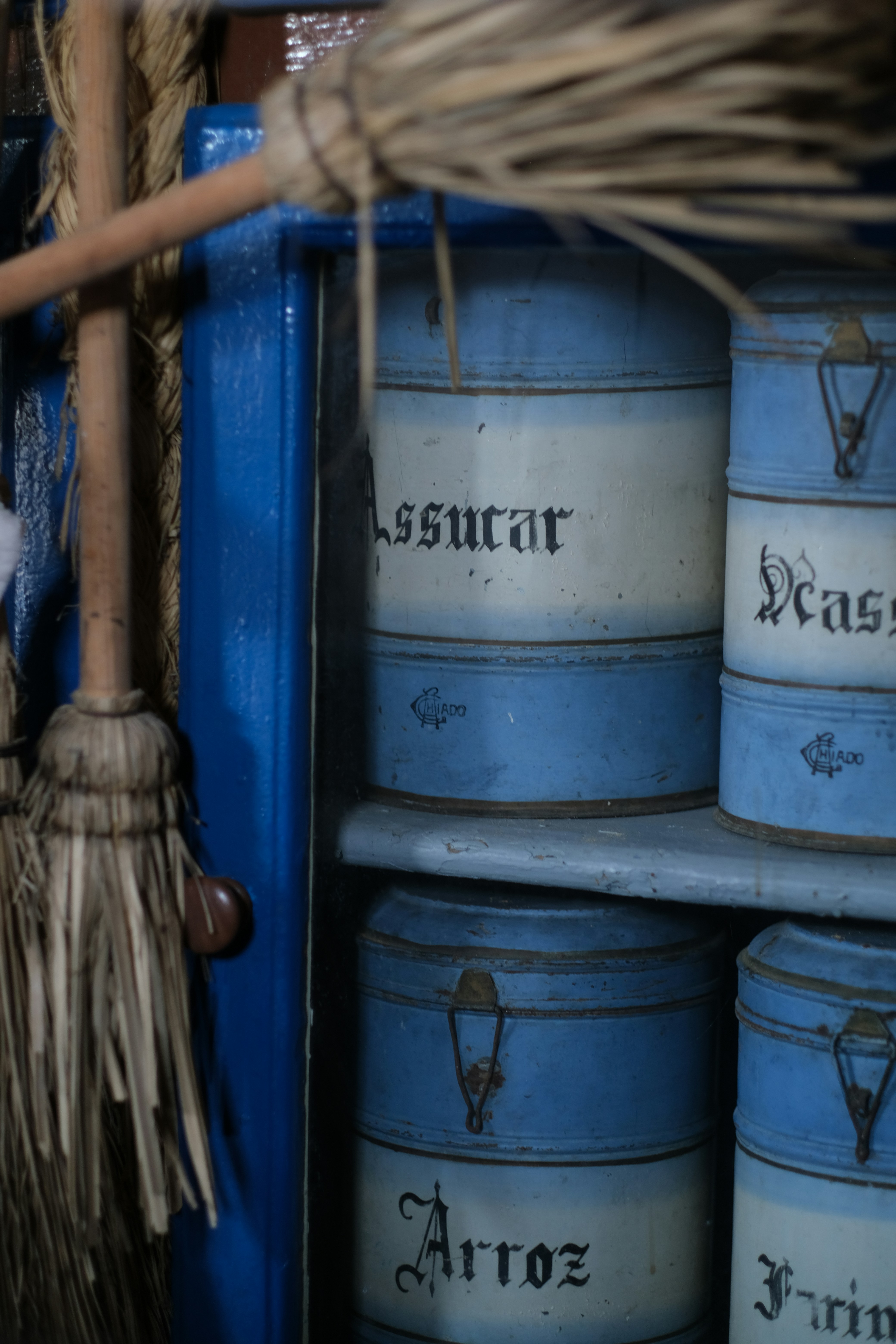 Arroz on Blue Tin: A Close-Up of Weathered Pantry Barrels