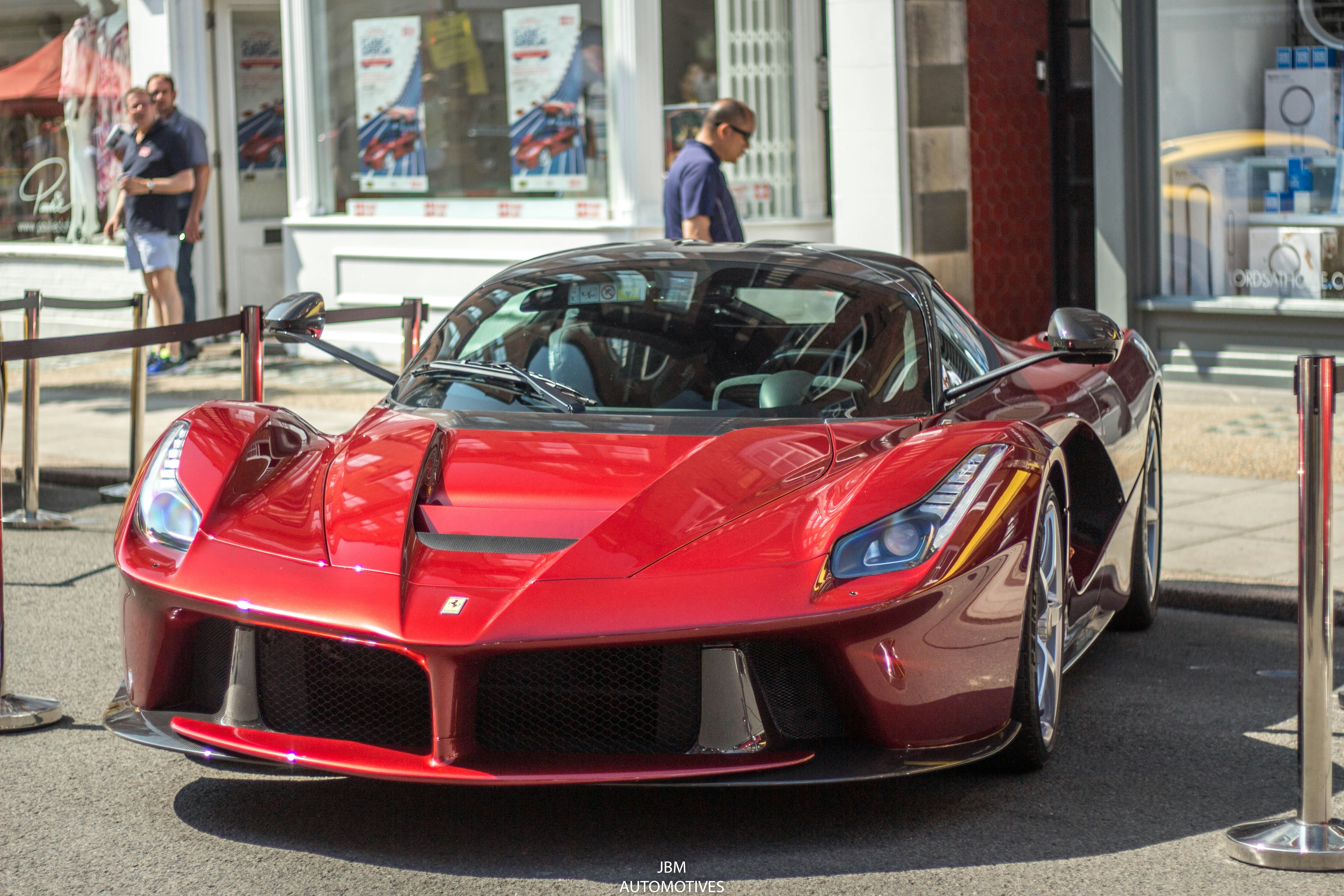 A red sports car parked outside a building photo – Free London Image on ...