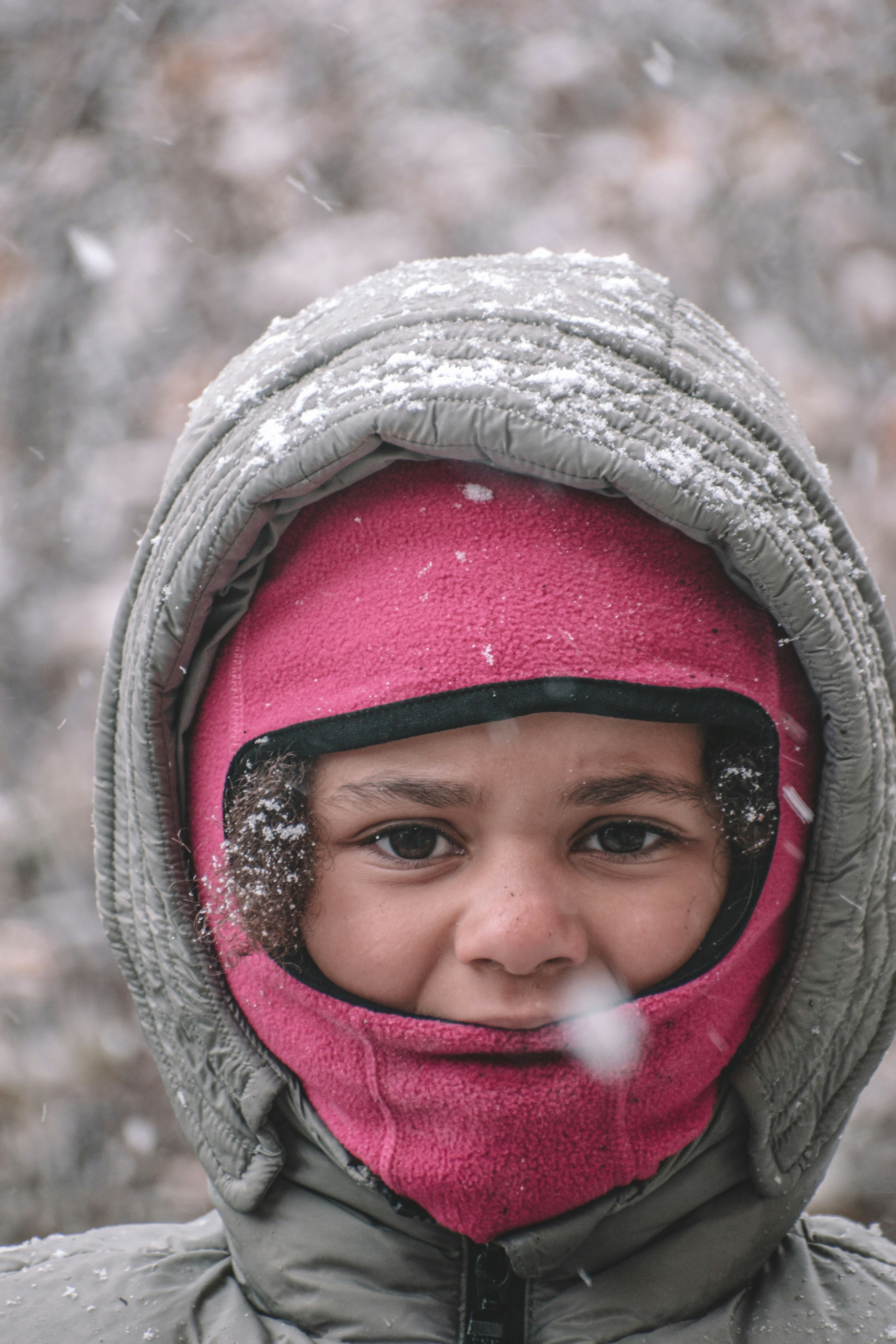 Child in first snow of the winter season, Canada