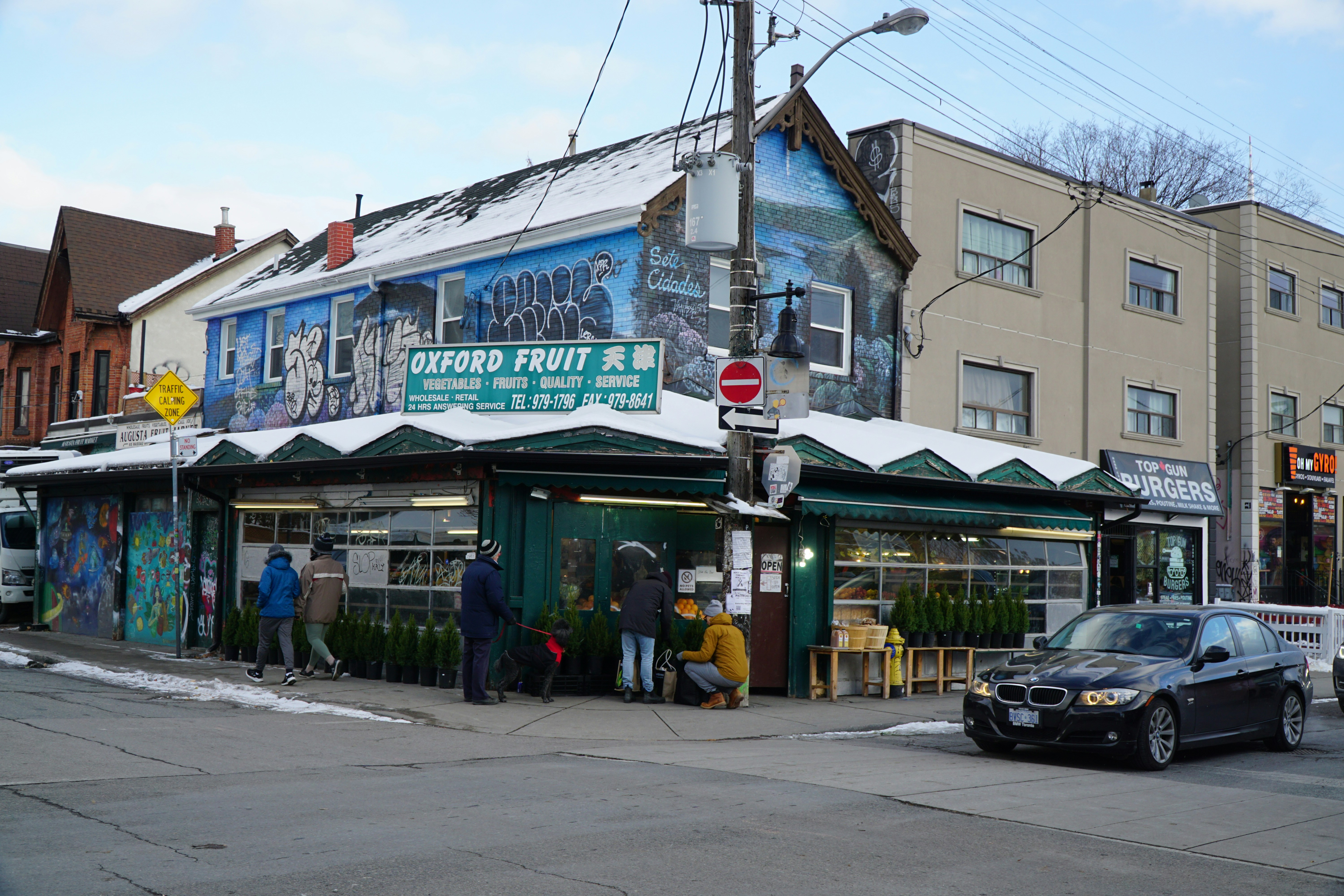 A group of people outside a store photo – Free Kensington market Image ...
