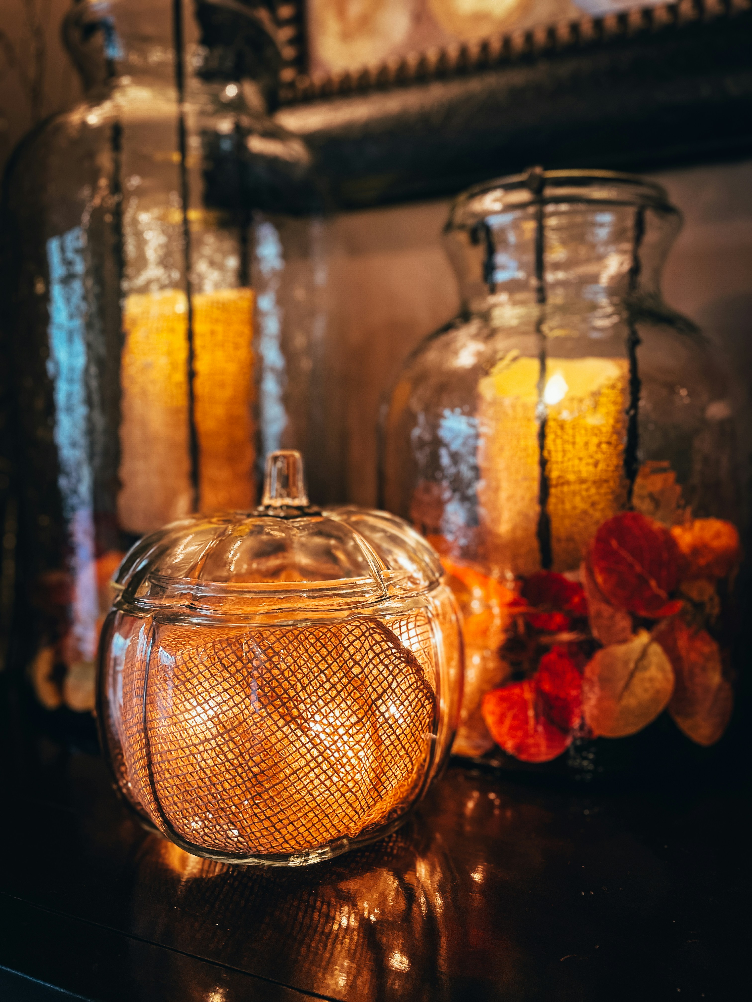 Glowing Citrus Jars: Warm Light Reflections in a Dim Still Life