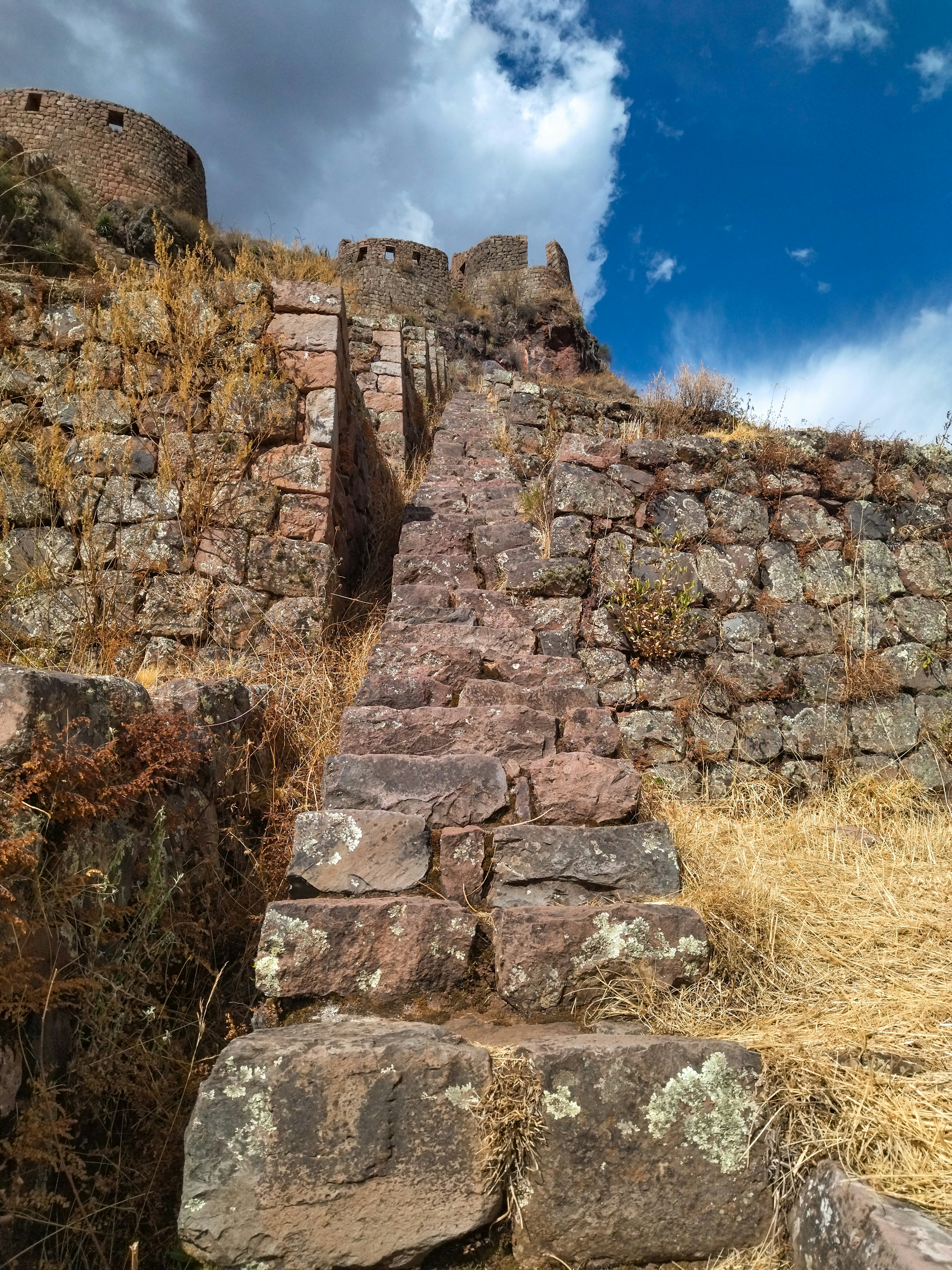 A stone wall with a stone building on top photo – Free Písac Image on ...