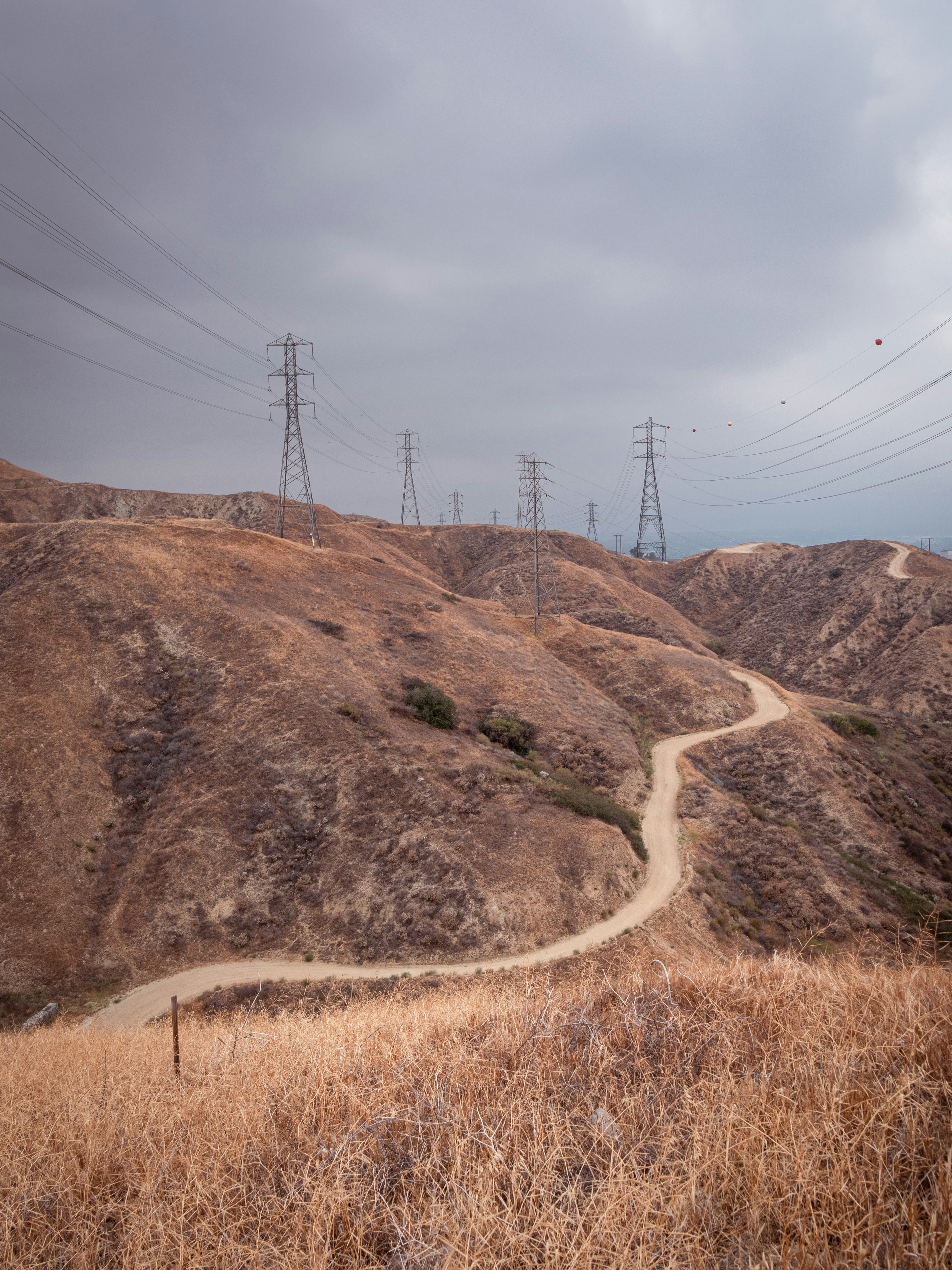 A dirt road with power lines on it photo – Free Moody Image on Unsplash