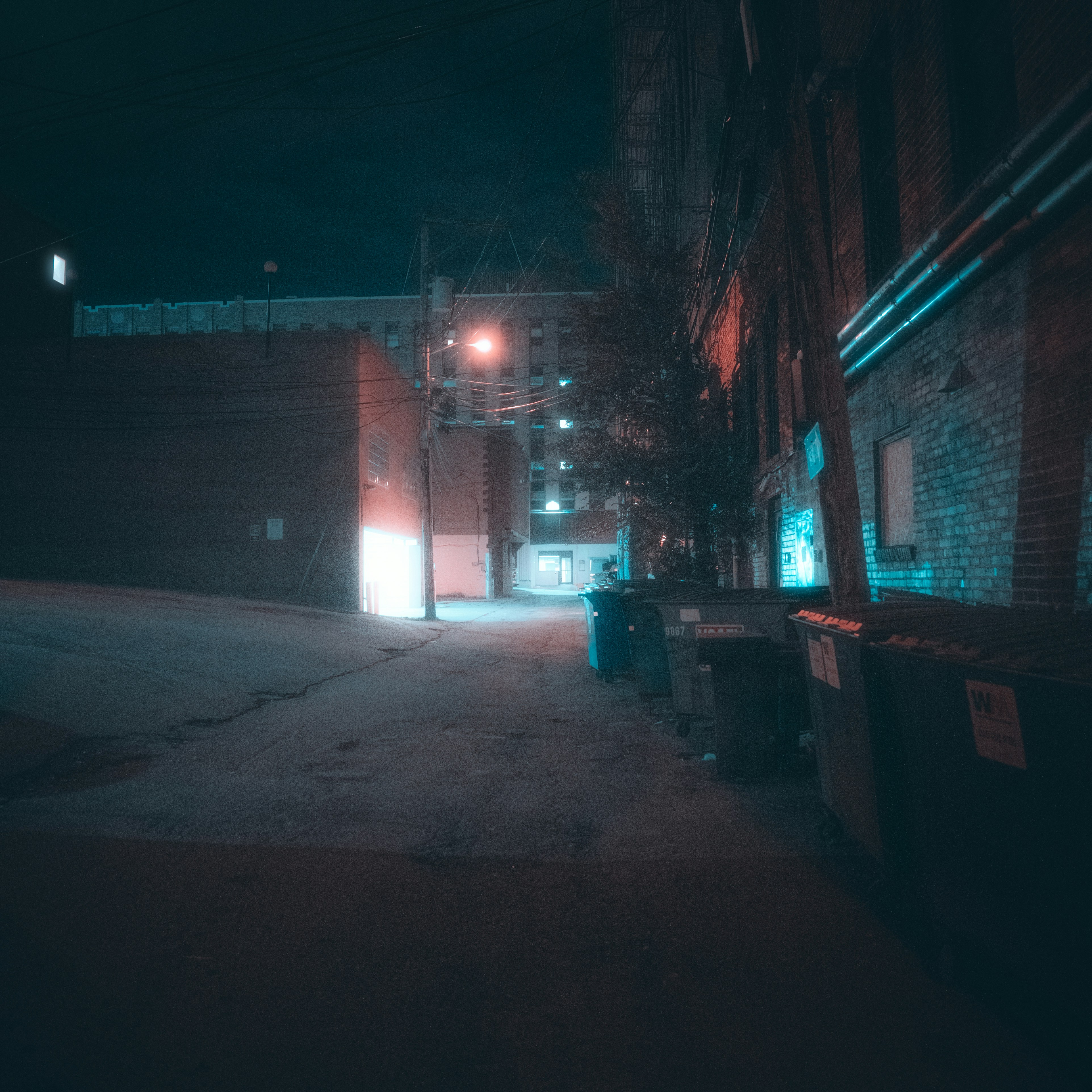 Blue Neon Alley: Quiet Corridor Between Brick Facades