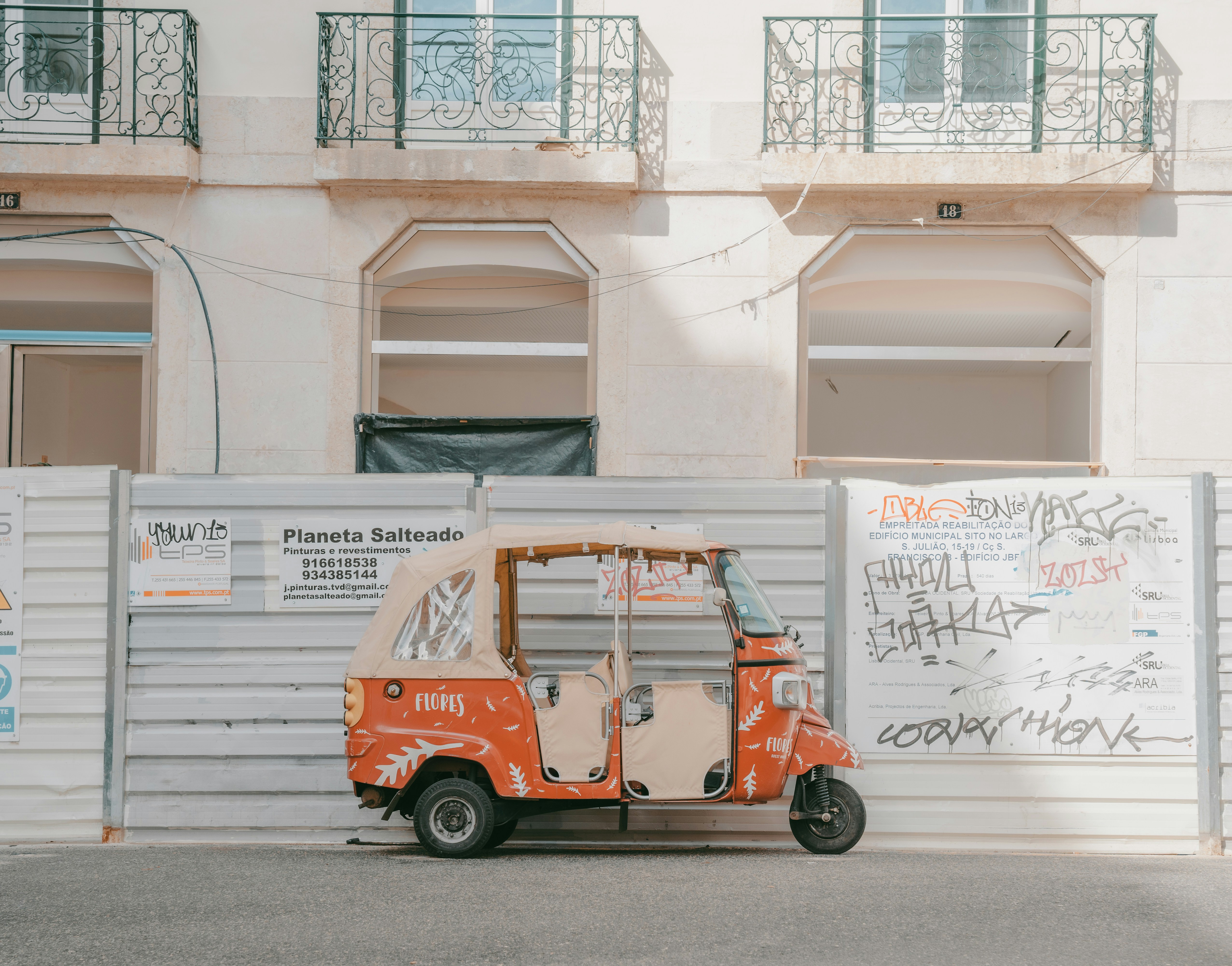 The Orange Ape on a Graffiti-Washed Street Under Pale Arcades