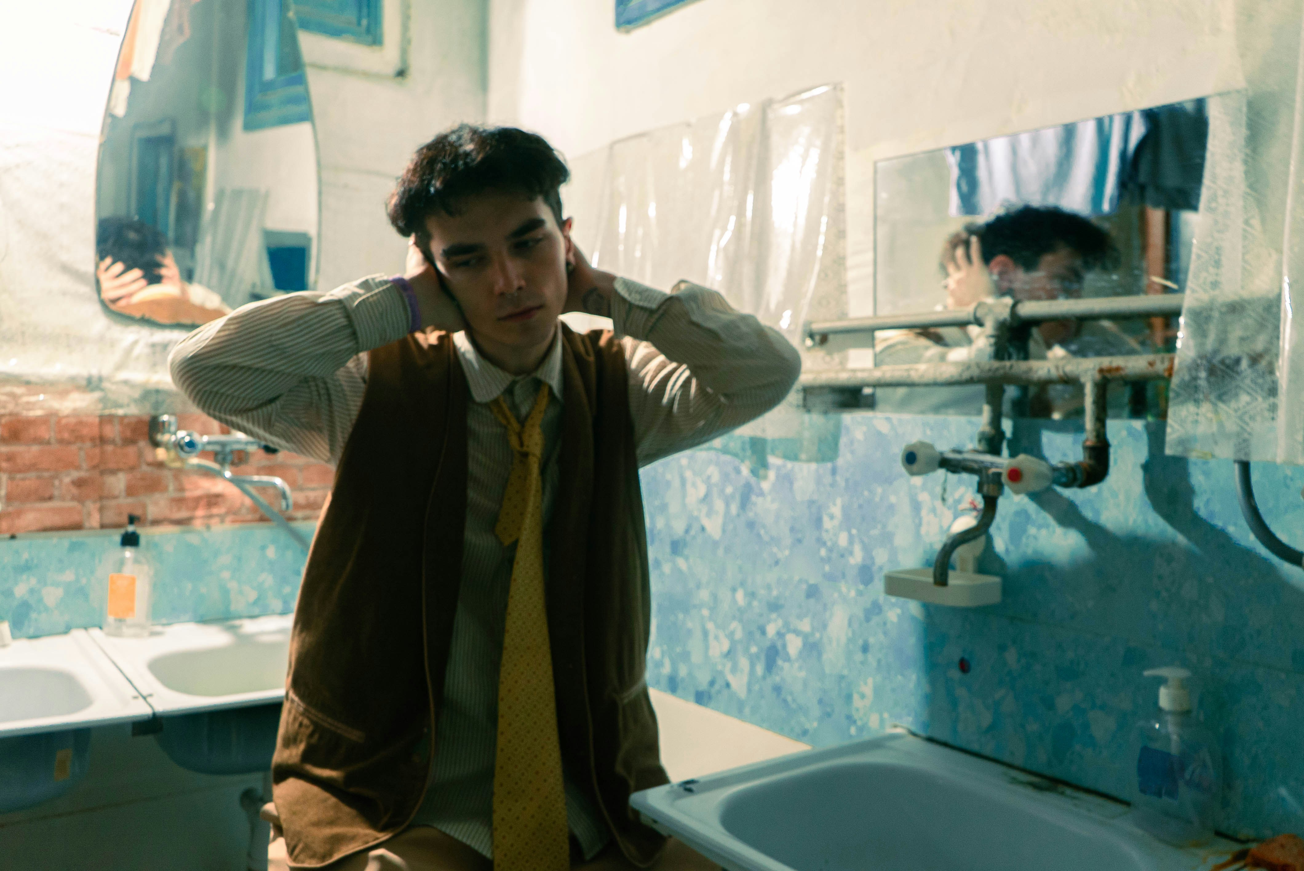 A person in a suit and tie in a bathroom photo – Free Basin Image on ...