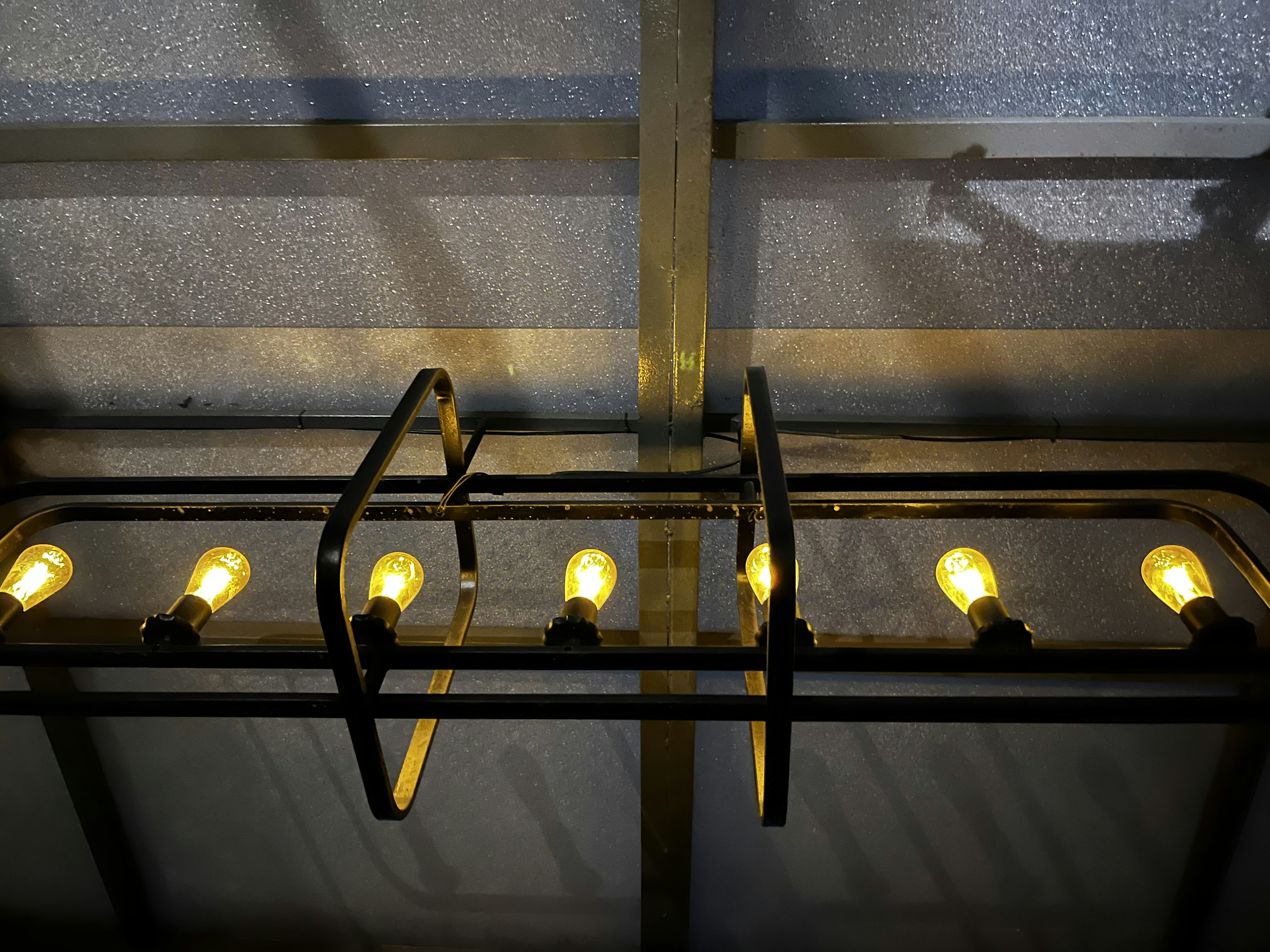 Glowing Filament Grid: A Softly Lit Fixture in an Industrial Ceiling