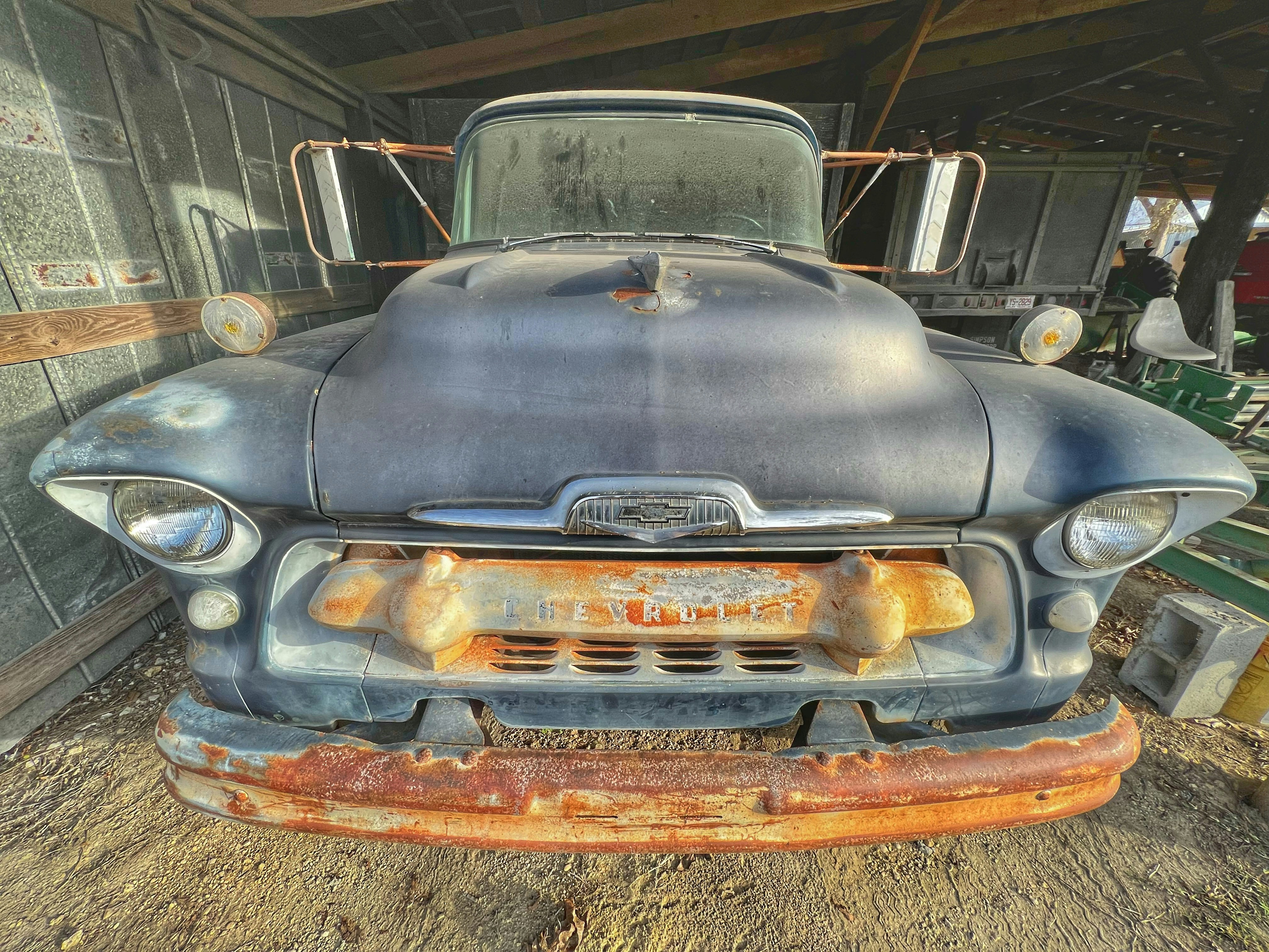 Old Chevrolet truck parked under a farm shelter in Pamlico County, North Carolina.