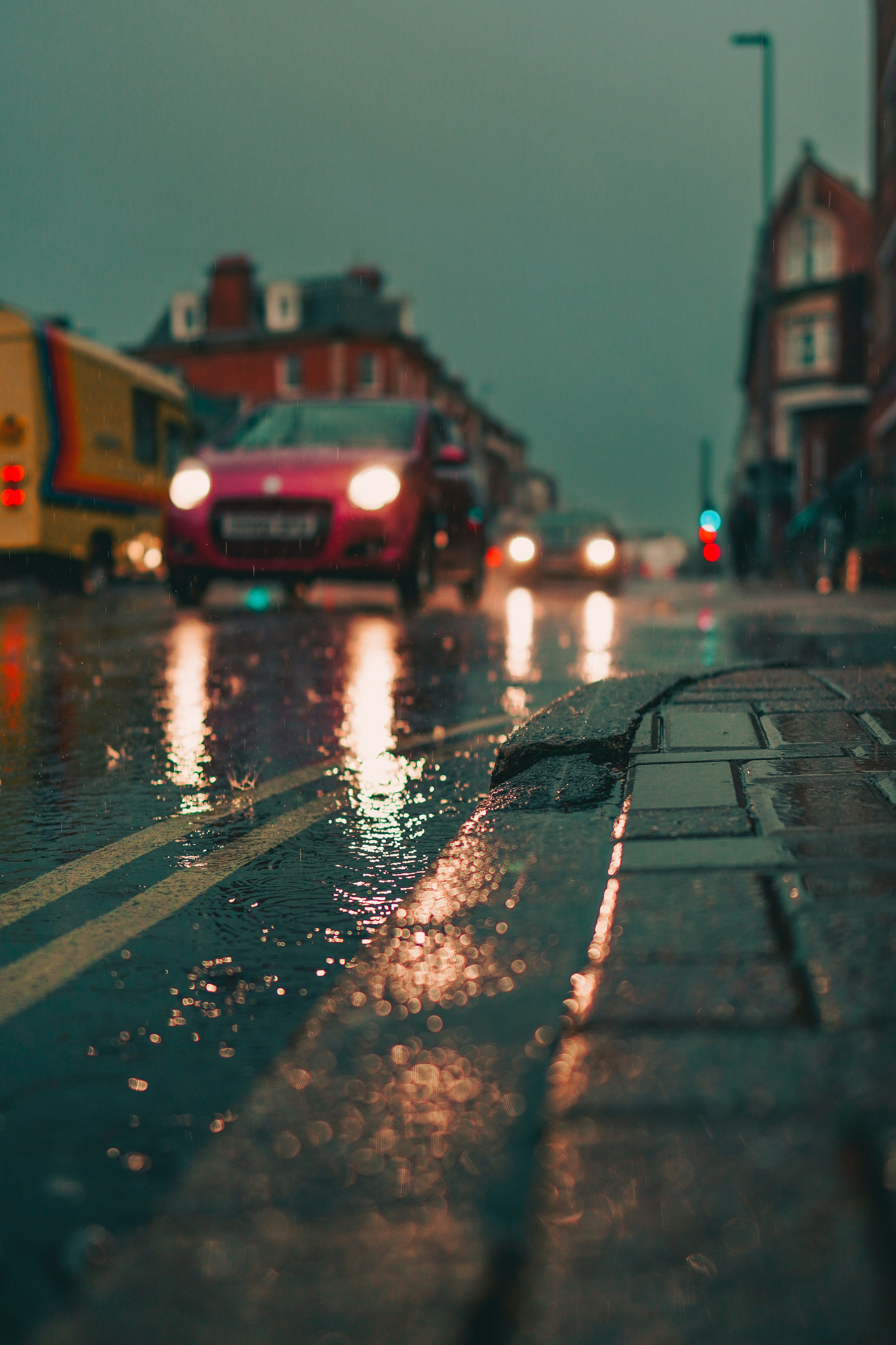 Headlights in the Rain: Neon Reflections on a City Street