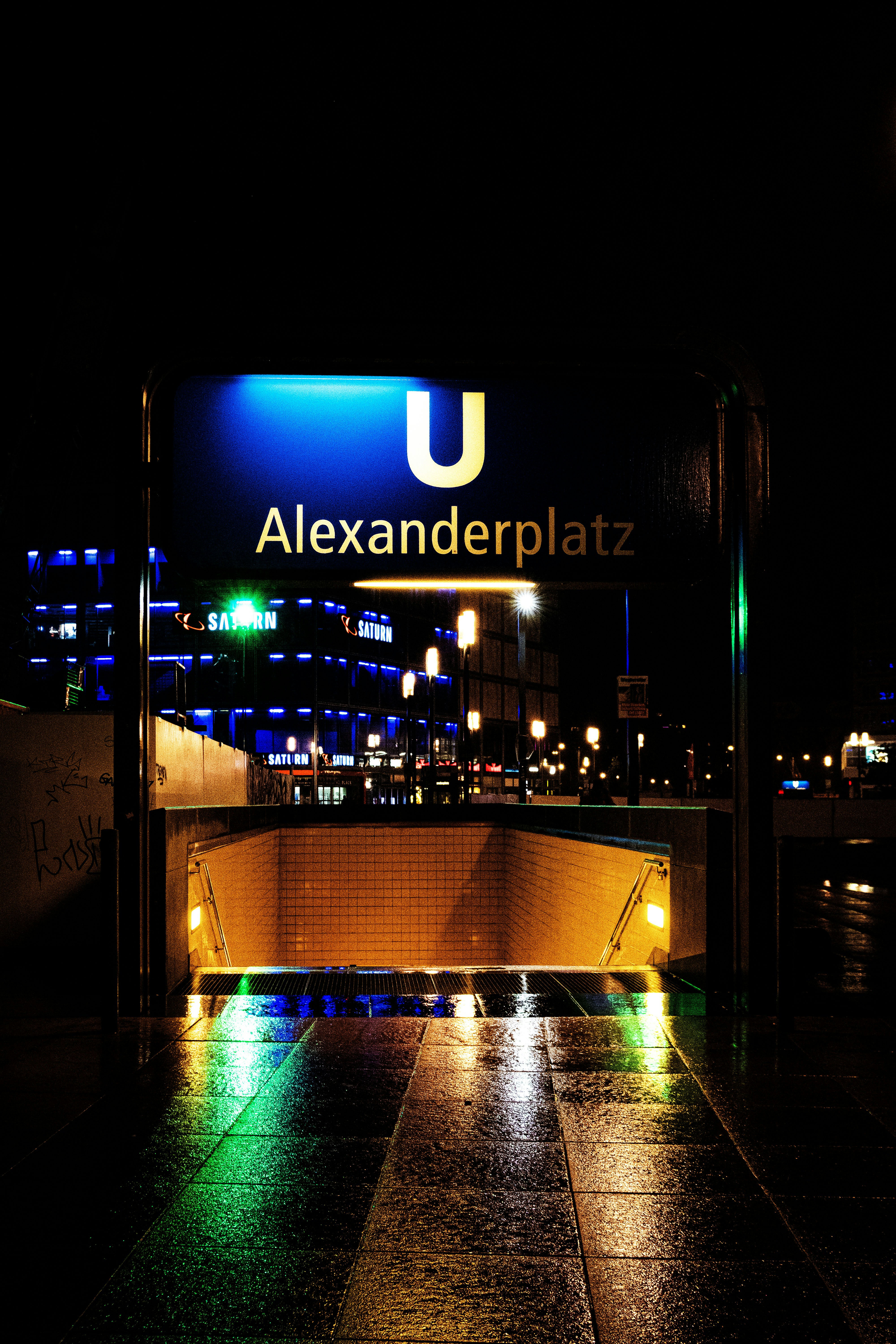 Blue U Sign Over a Neon-Drenched Entrance at Alexanderplatz