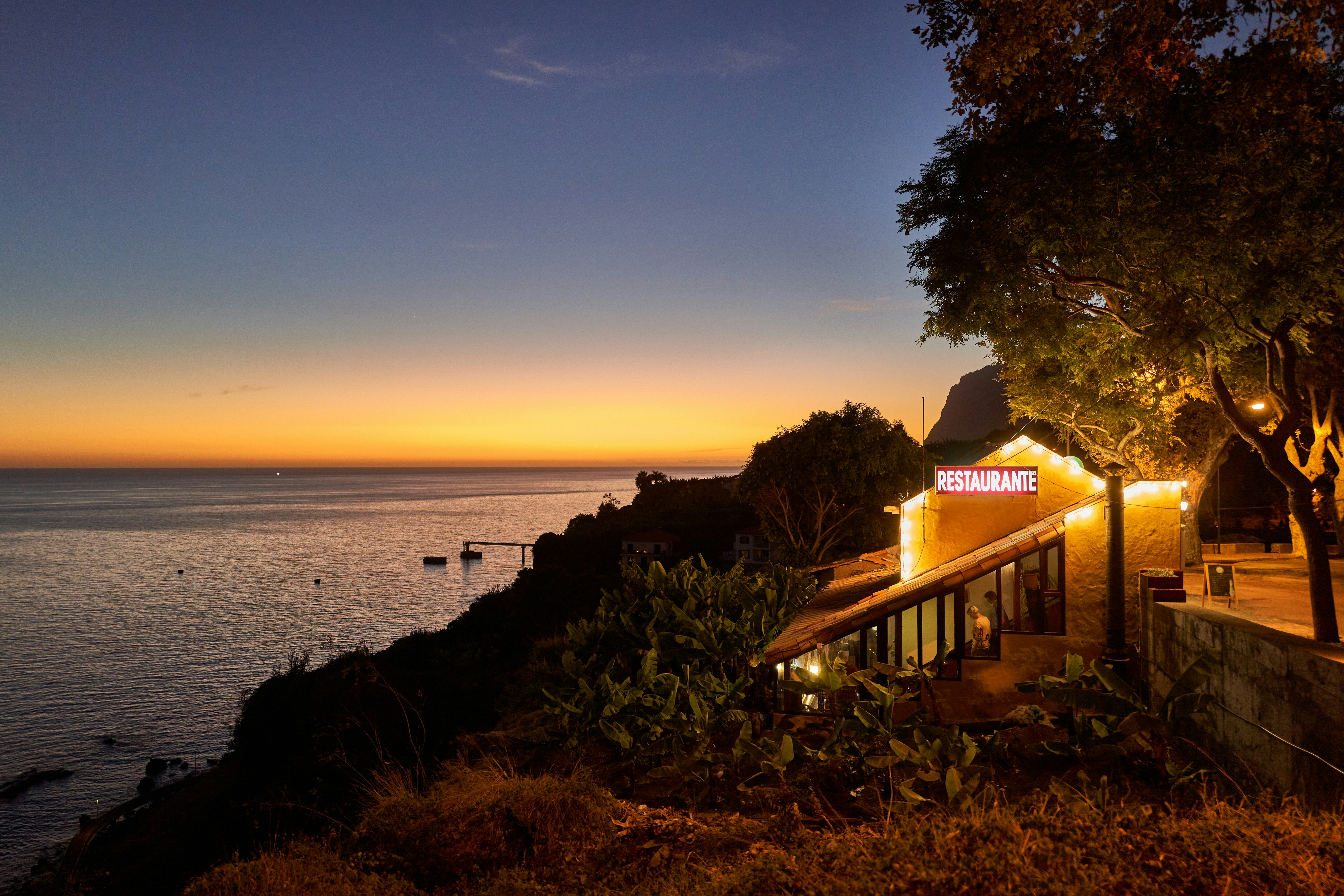 Dusk on the Cliff: Warm Light Framing a Quiet Sea Horizon