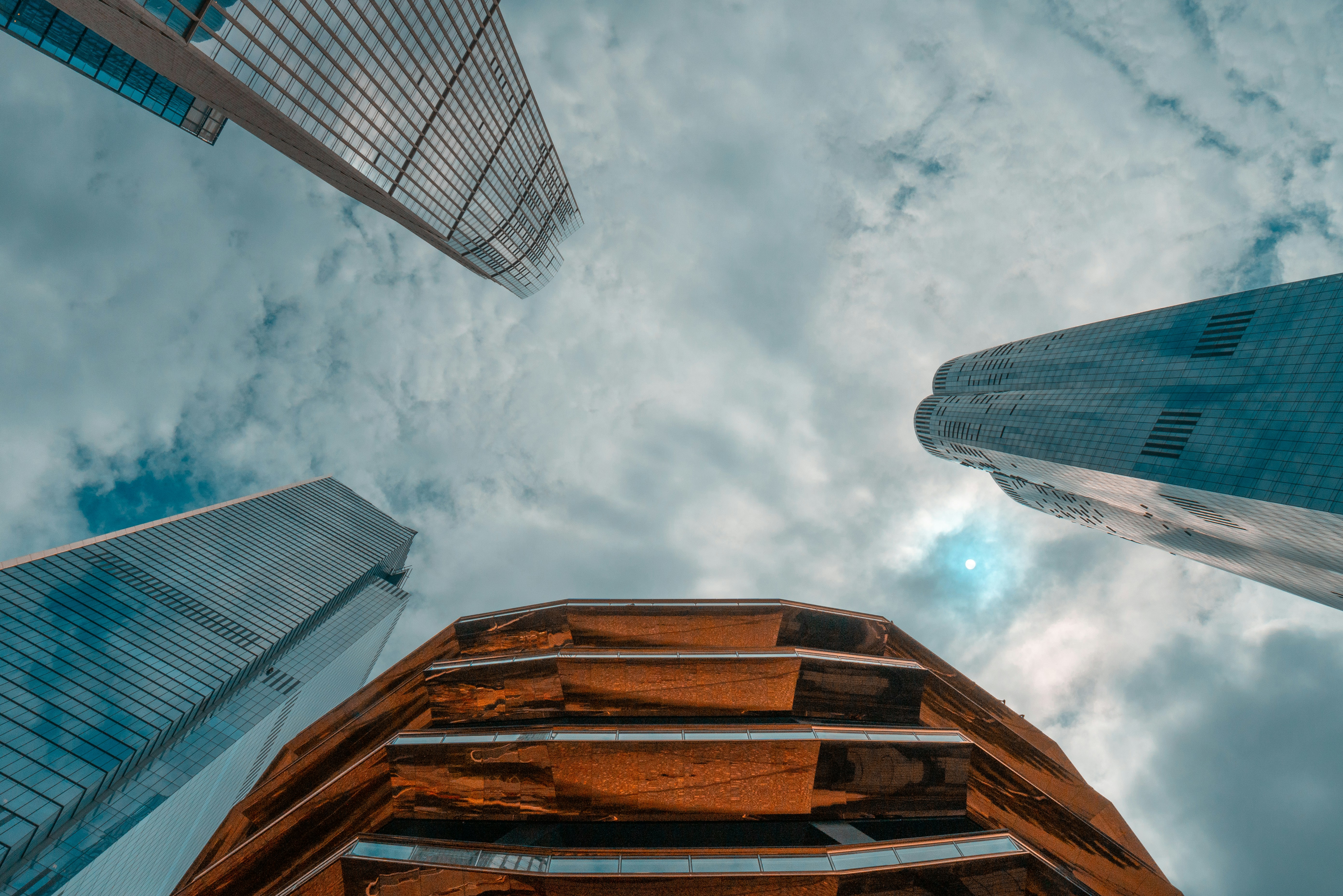 Towering Ascent: A Skyward Void Framed by Glass and Brick