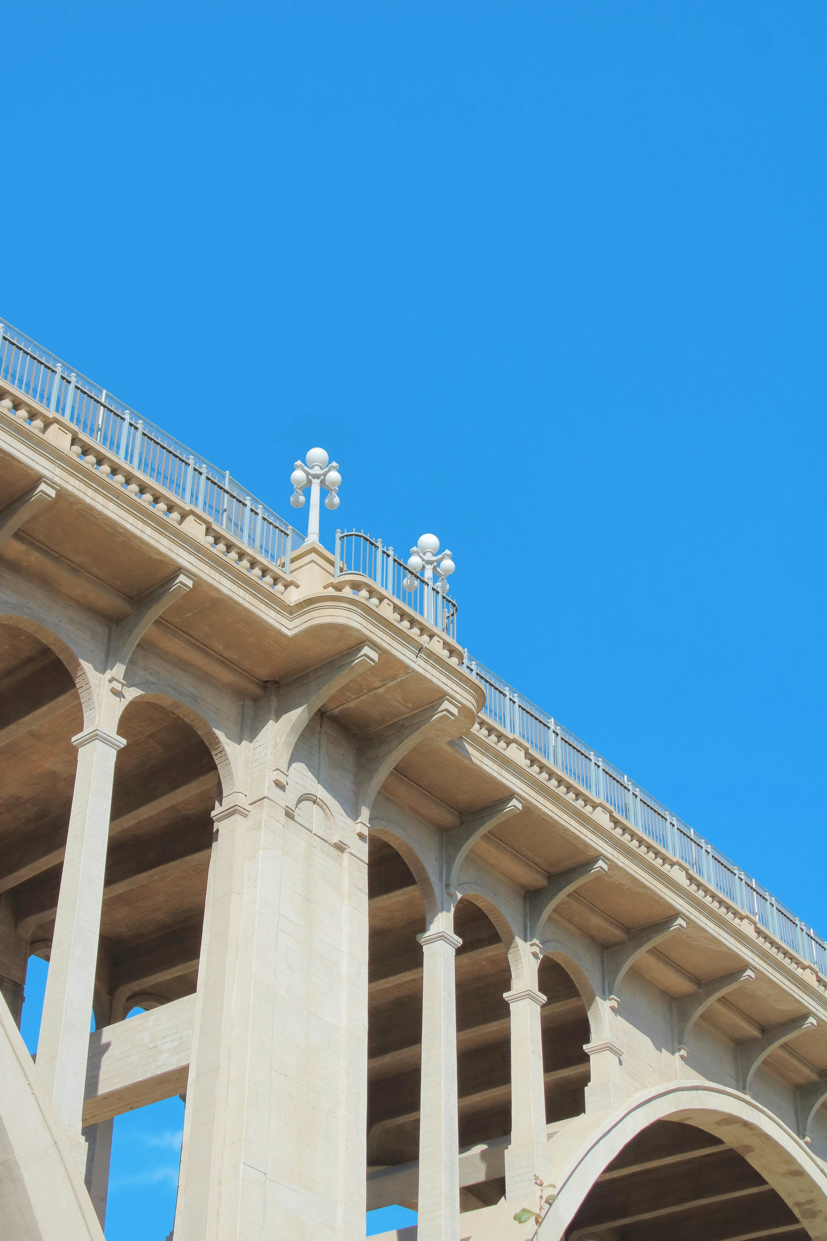 Azure Span: Concrete Arches under a Cerulean Sky