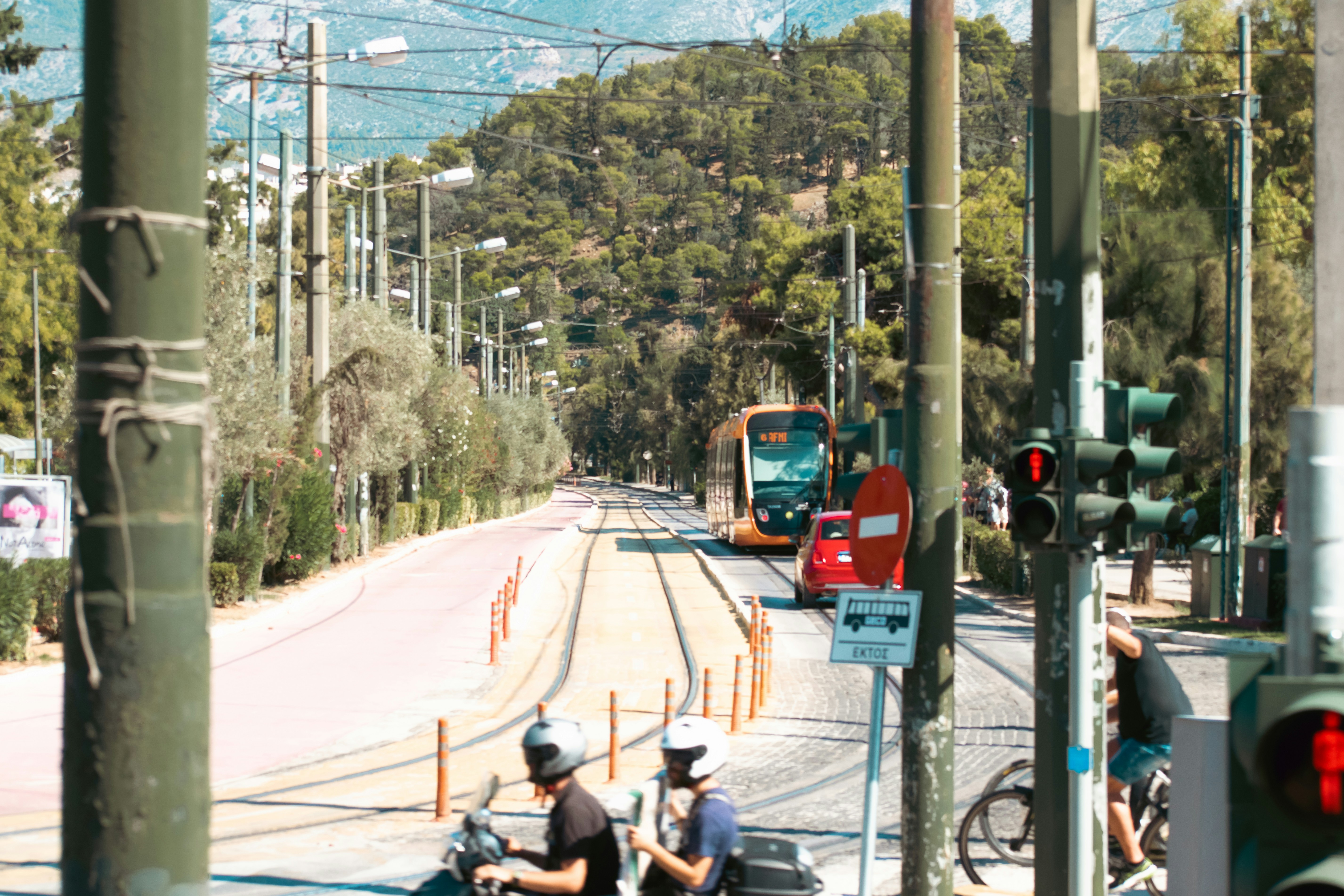 Sunlit Tram Corridor: Rails, Poles, and Quiet City Movement