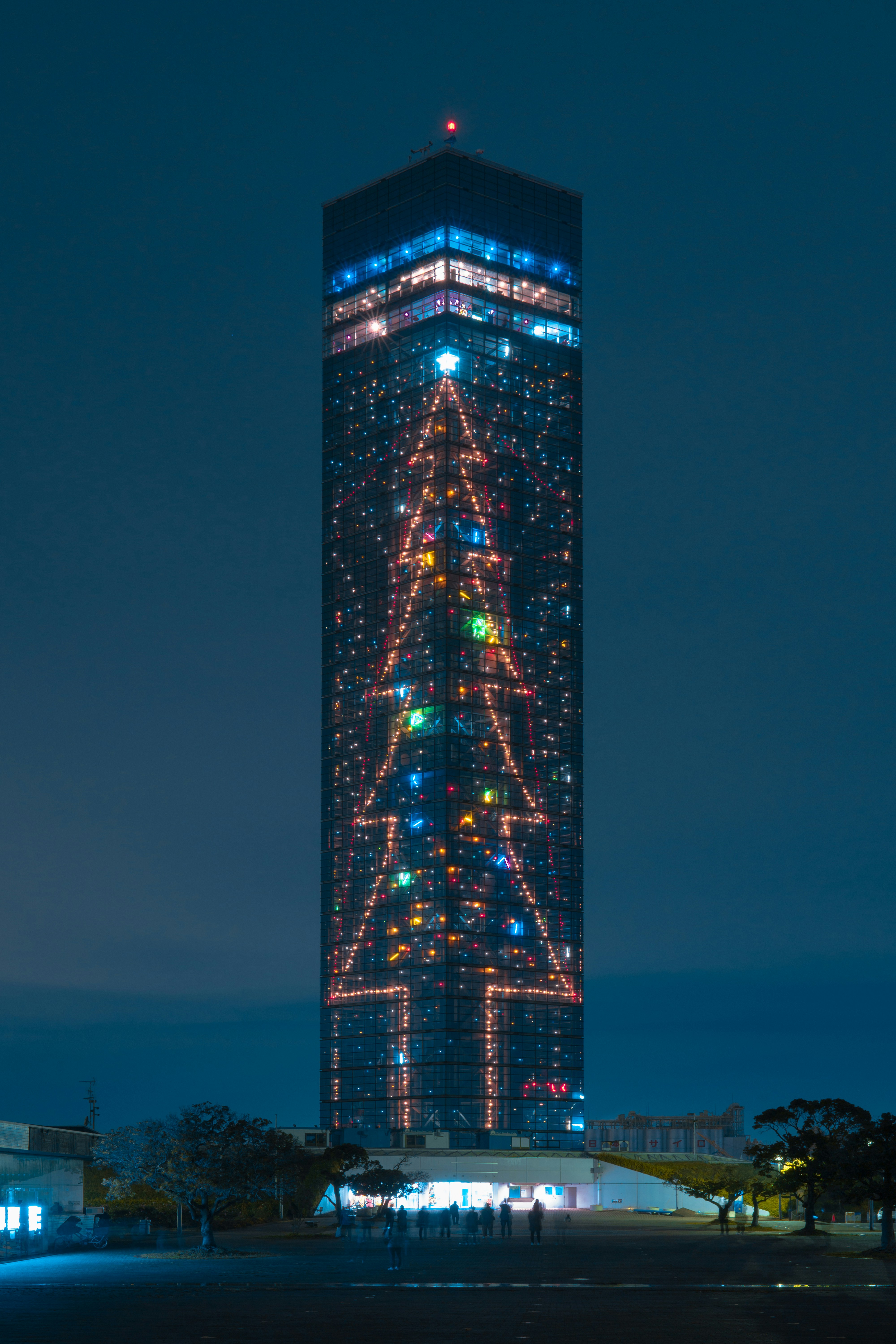 Prismatic Neon Tower: A Nighttime Facade Wrapped in Colored Light