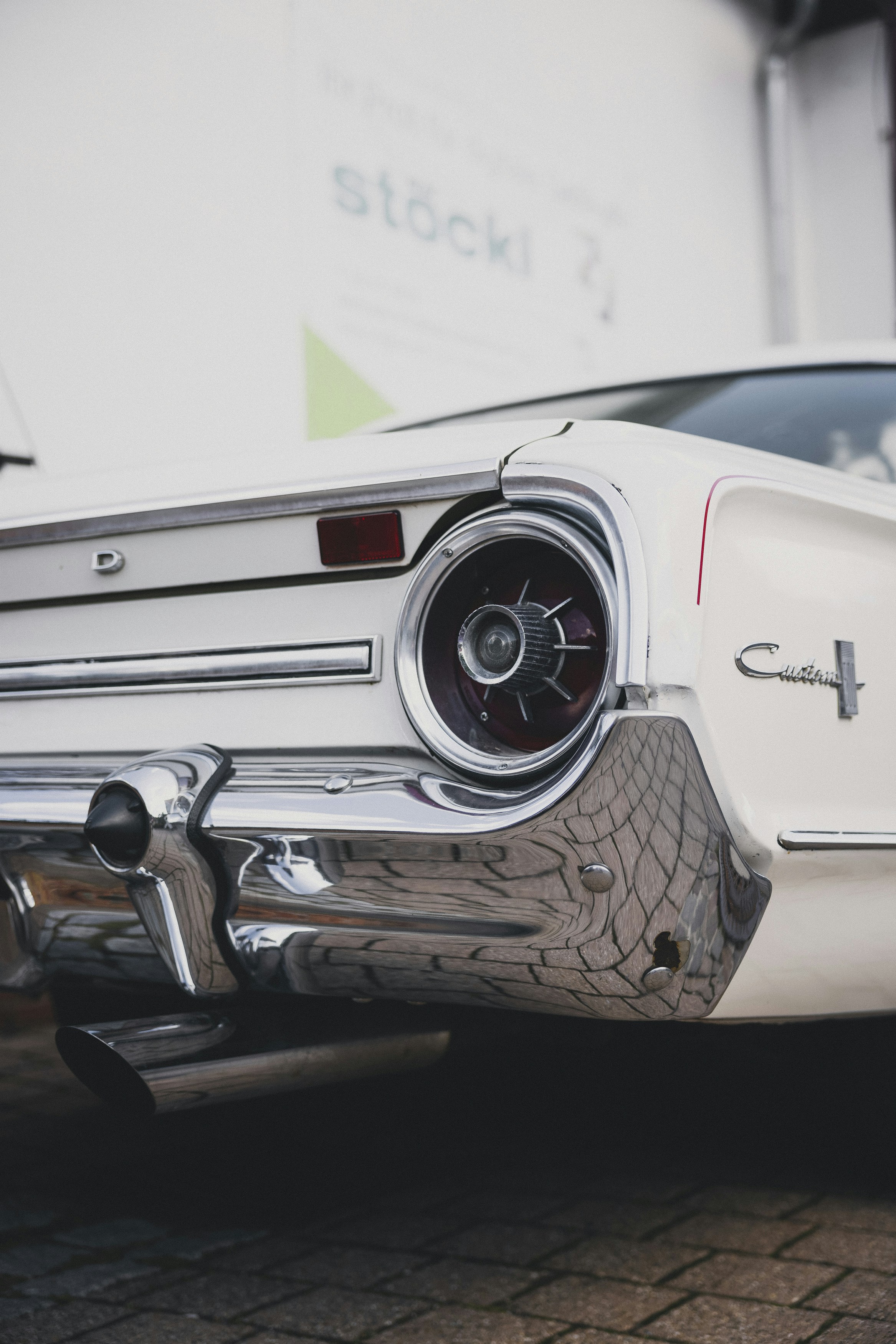 Chrome Halo: The Circular Taillight on a White 1960s Classic