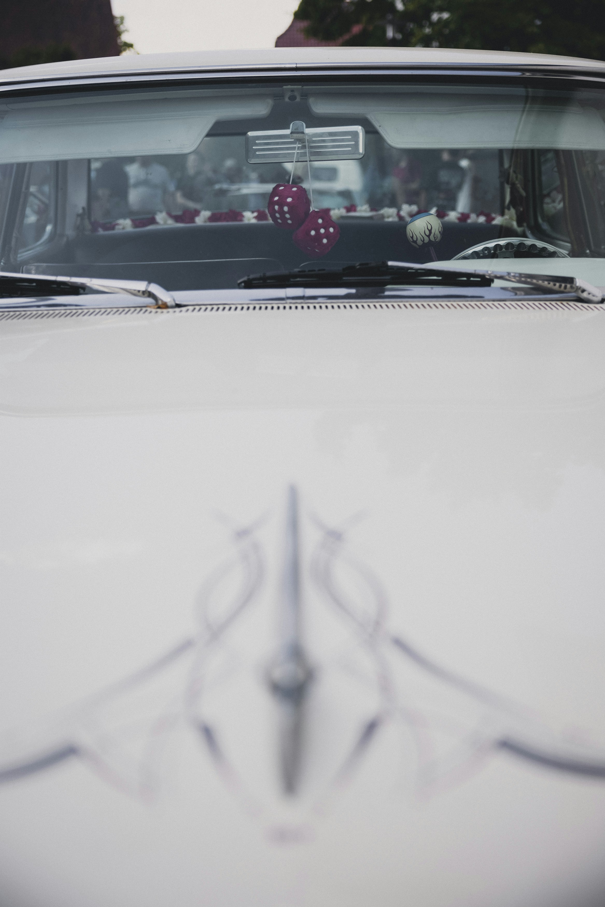 Red Dice in the Rearview: A Vintage Car's Quiet Charm