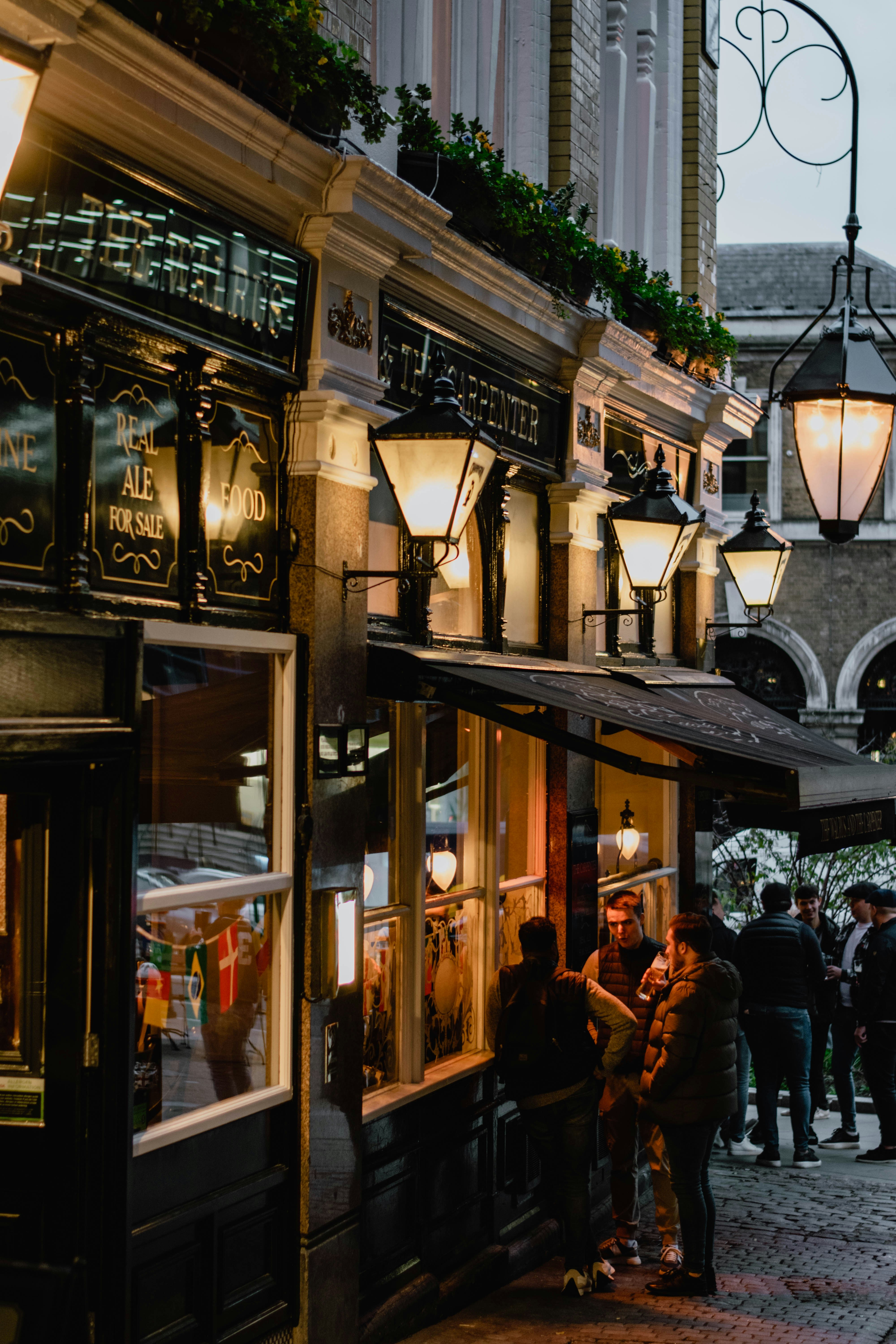 A group of people standing outside a building photo – Free London Image ...