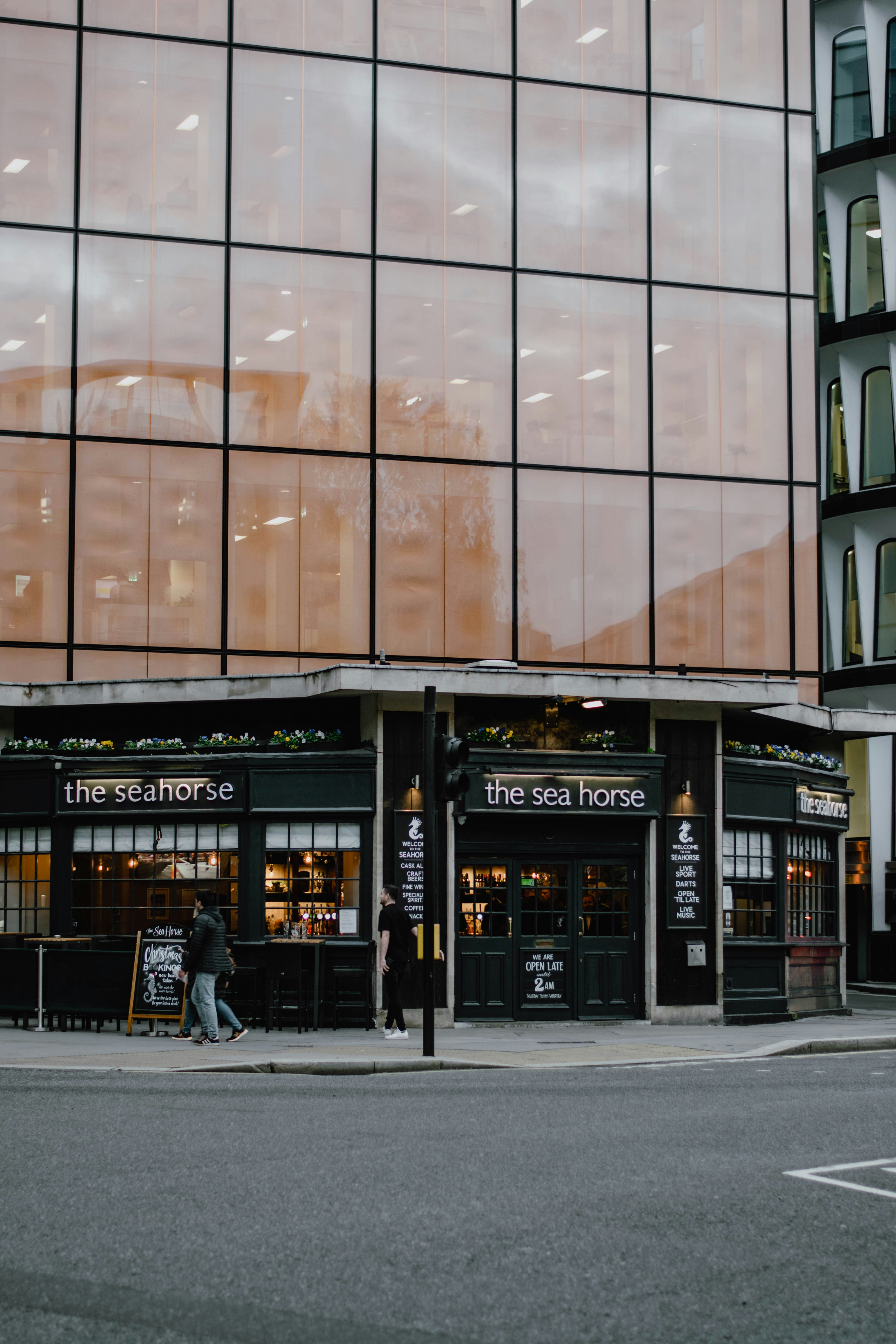 a building with windows and people walking by it