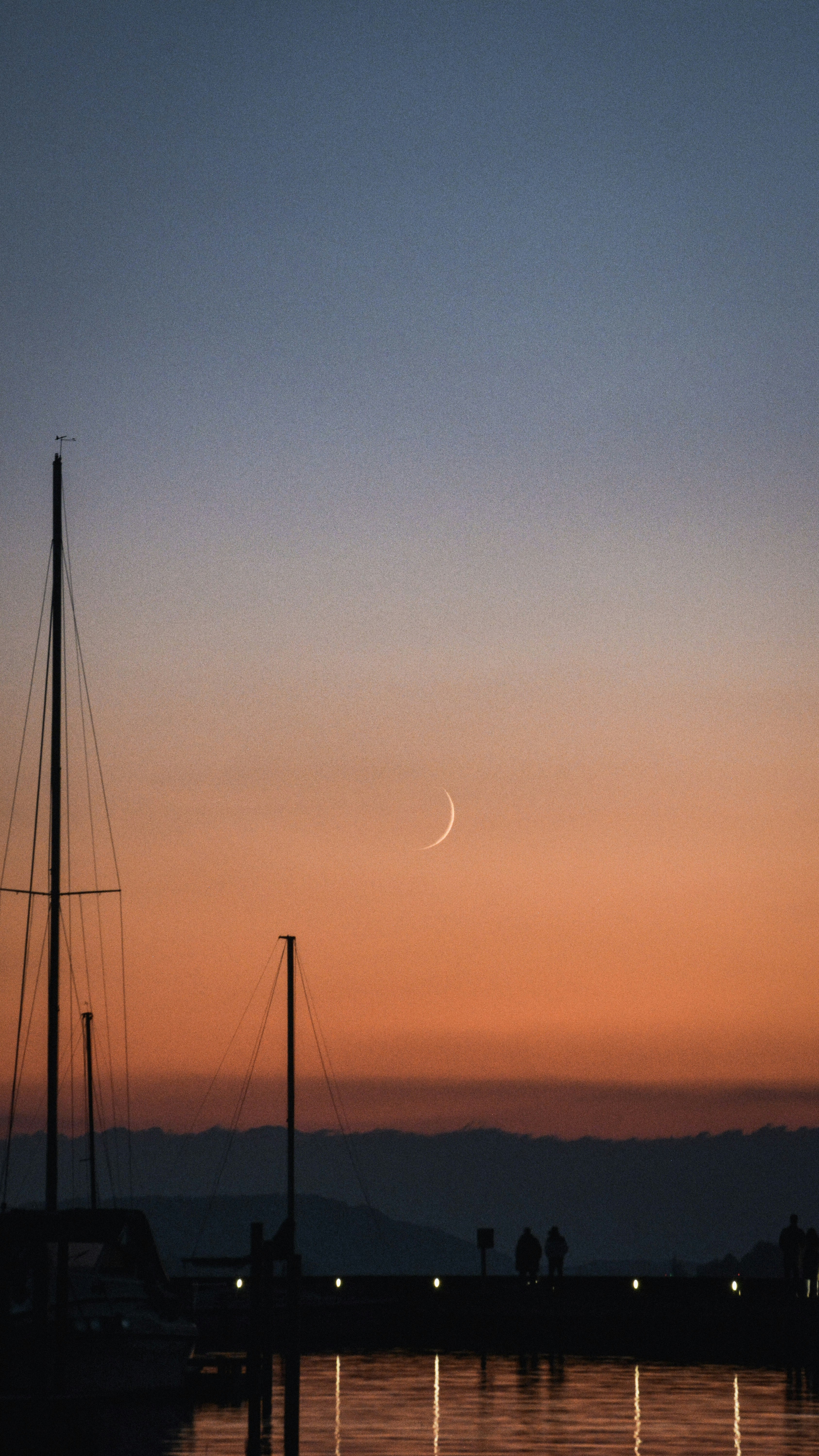Crescent Moon Over a Quiet Marina at Dusk
