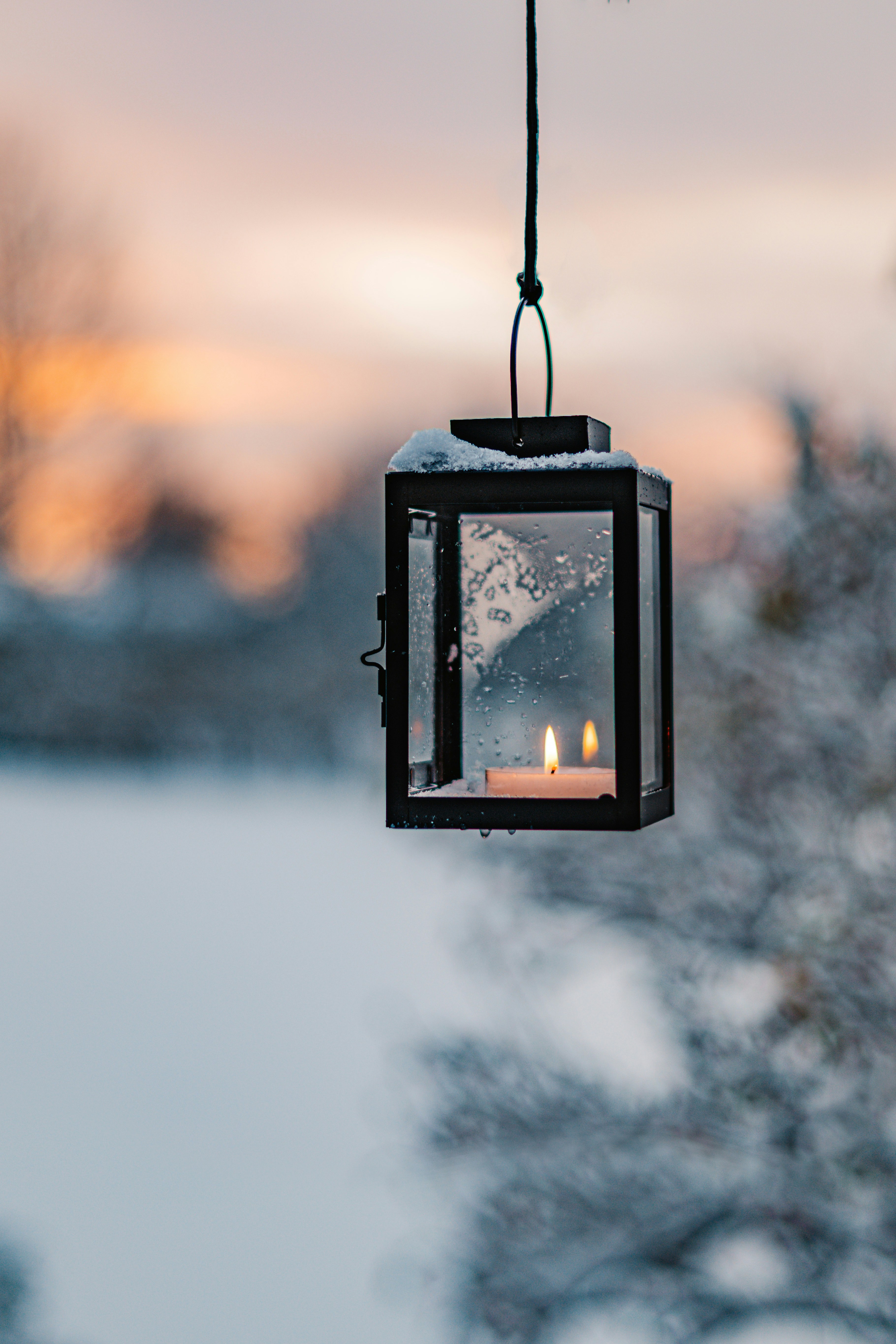 Winter Lantern Hang: A Tiny Candle in Frost Against Dusk