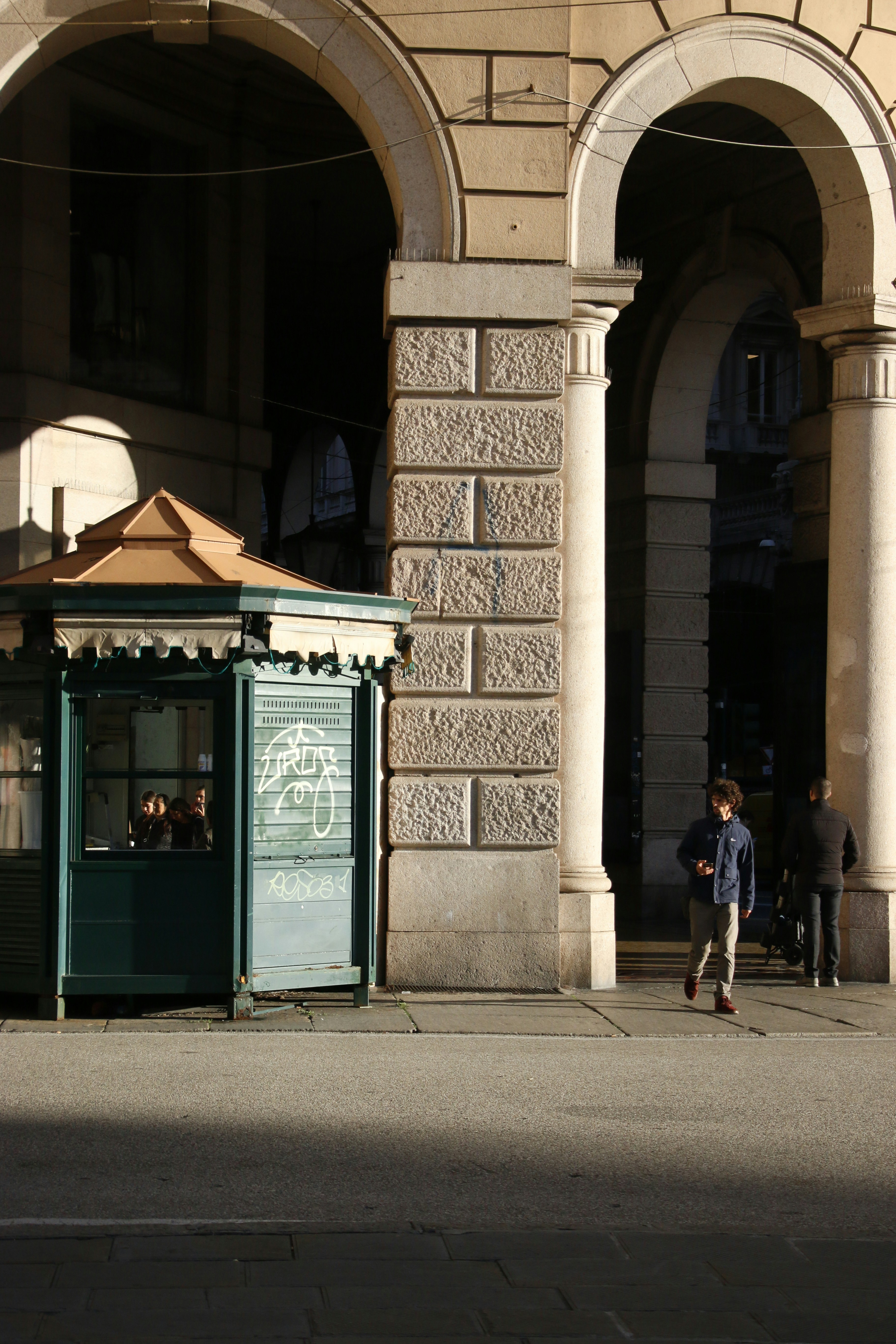 Dappled Light on Stone Arches: A Street-Level Moment