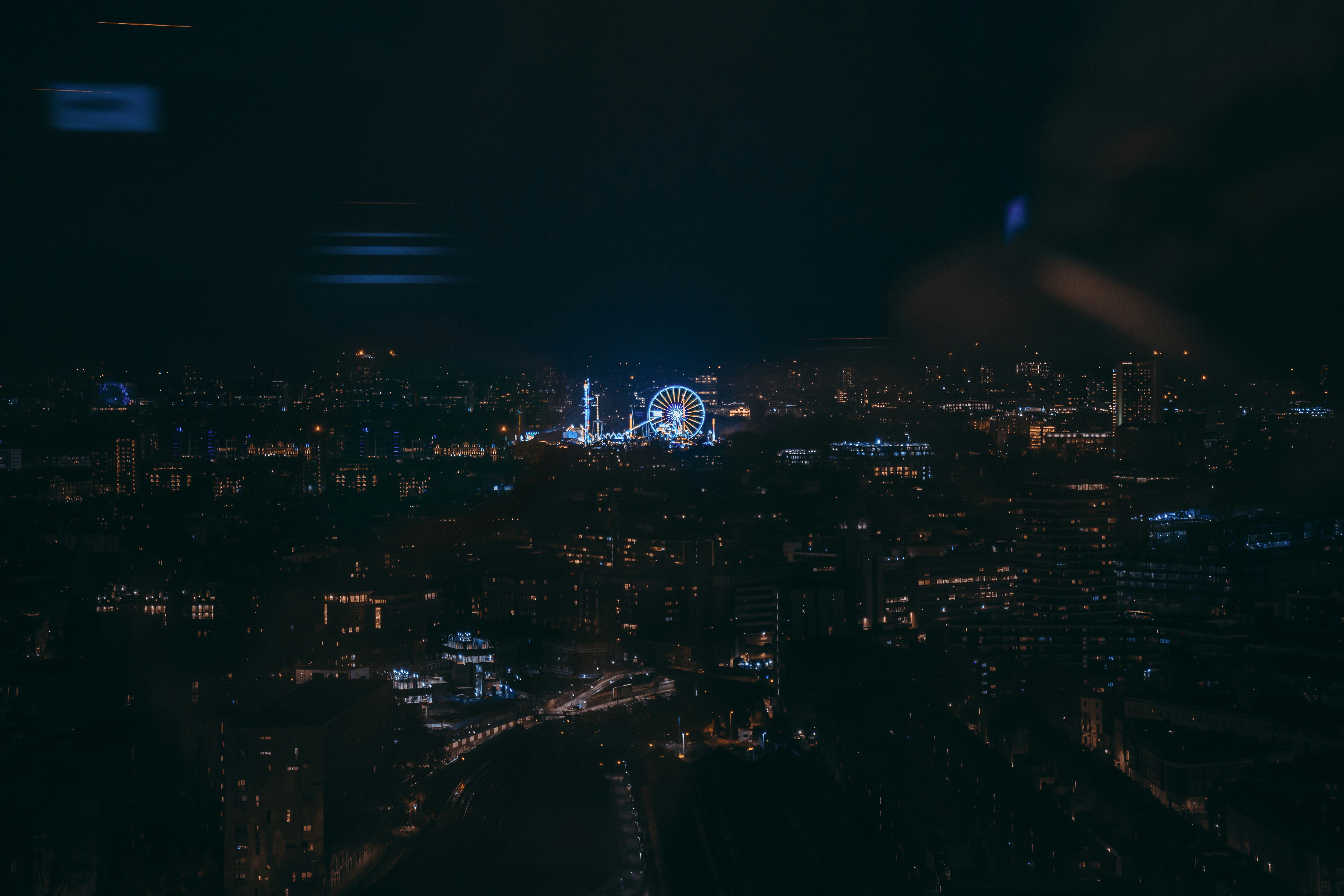Midnight Atrium: A Ferris Wheel Glows Over a Quiet City