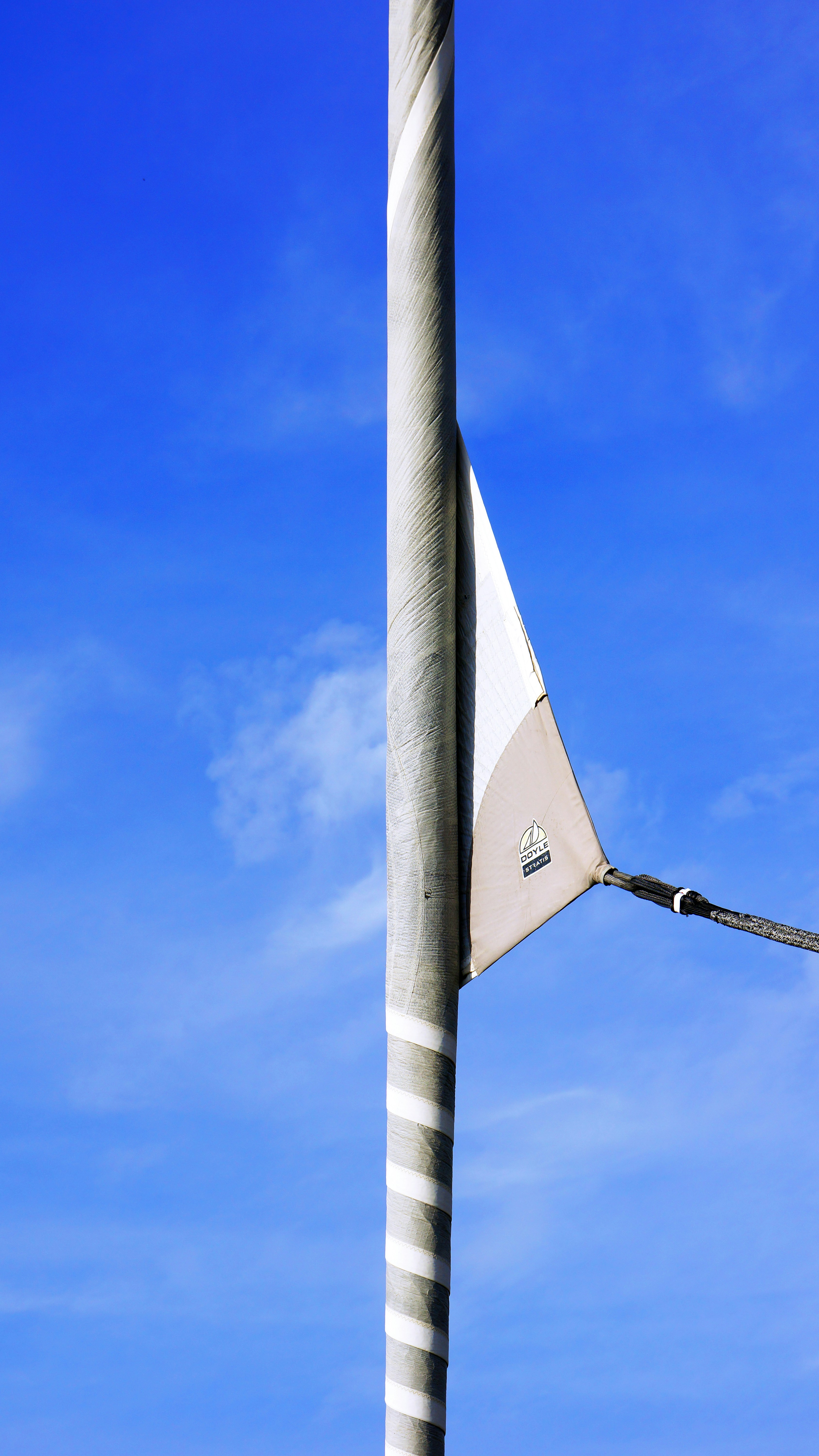 Cerulean Geometry: A Steel Pole, Triangular Sail, and a Boundless Sky