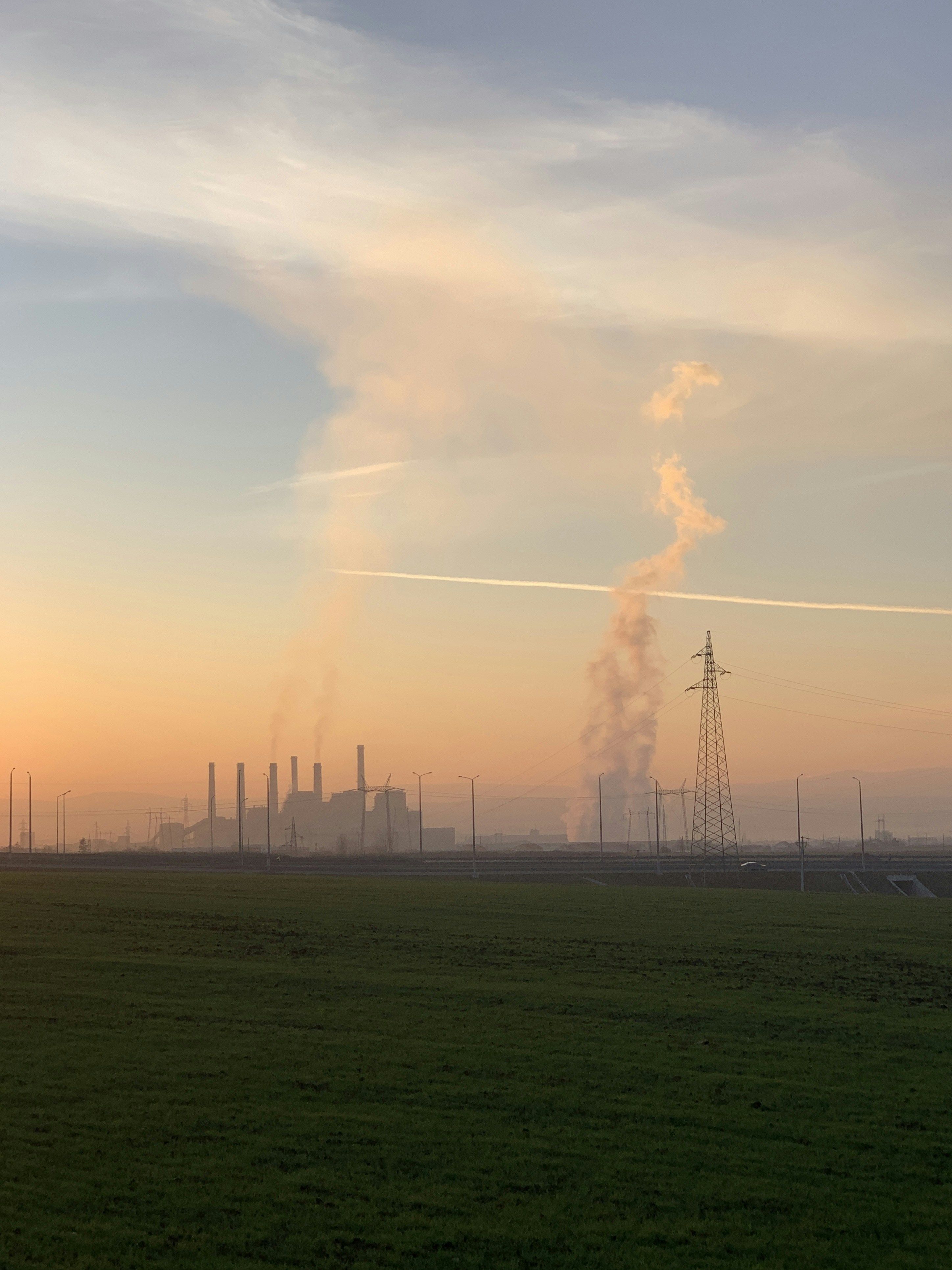 Dawn Over the Industrial Horizon: Steam, Smoke, and Power Lines