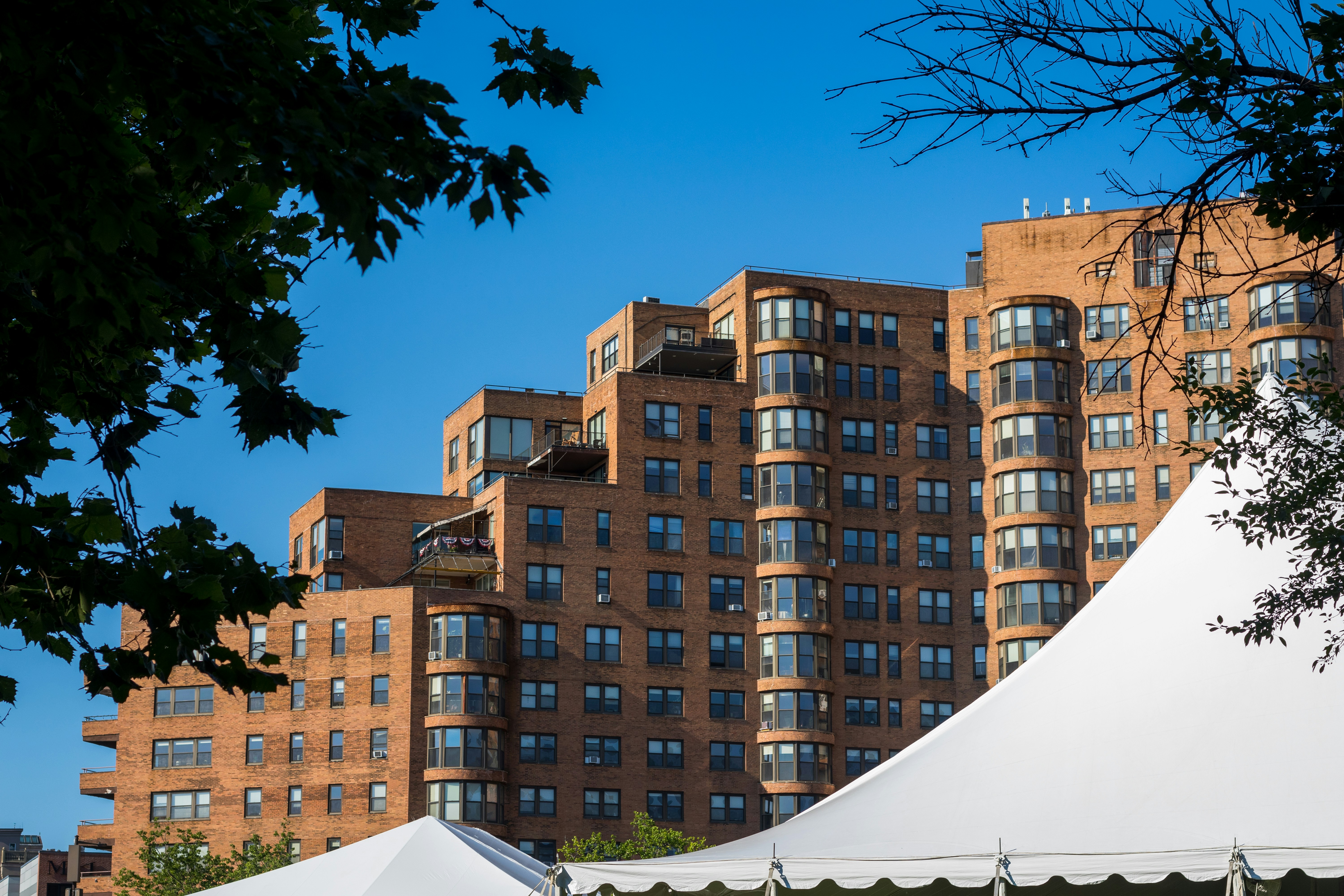Brick-Clad Towers Rise Behind a Crisp White Canopy Under a Cobalt Sky