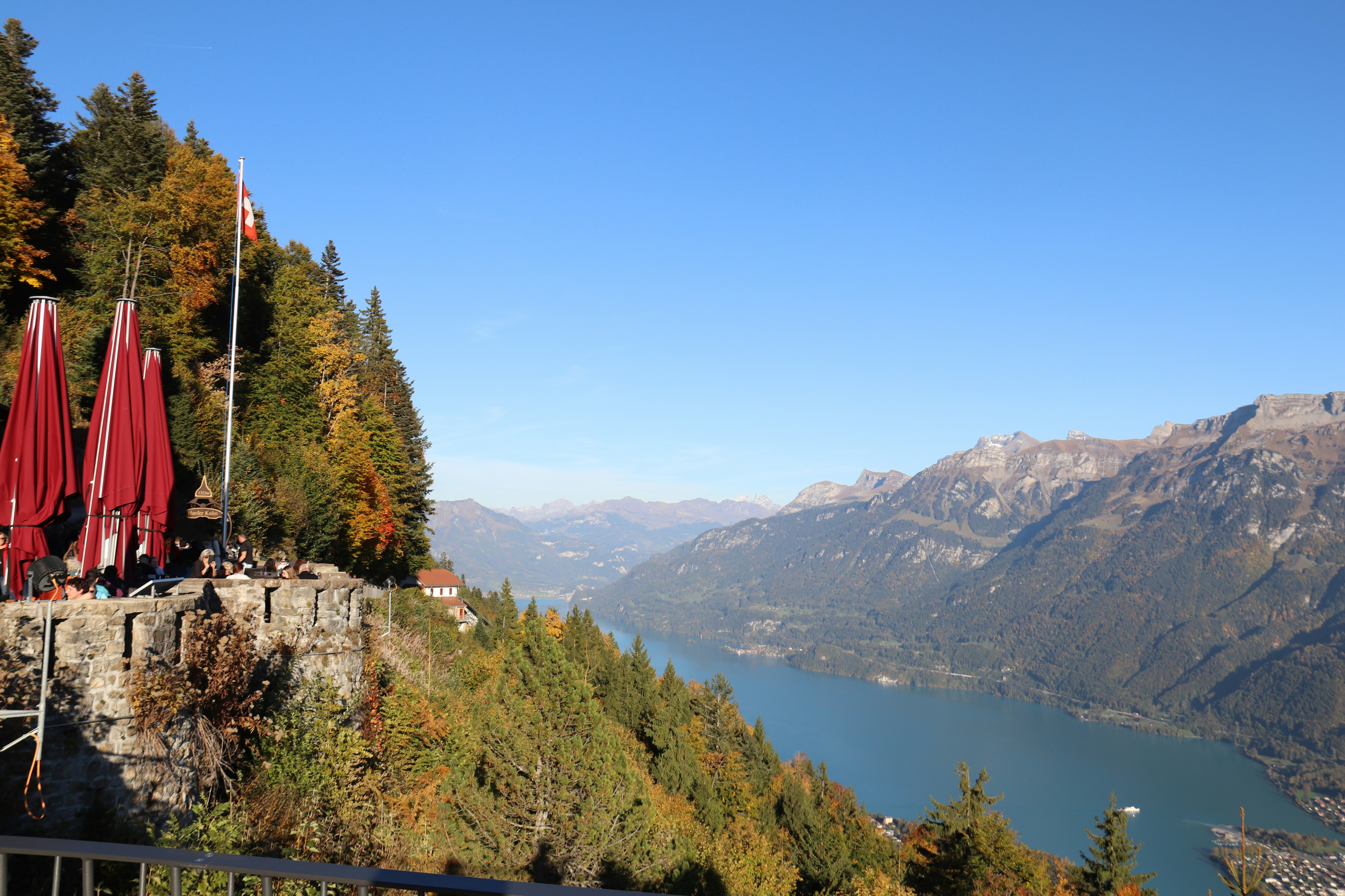 a body of water with trees and mountains around it