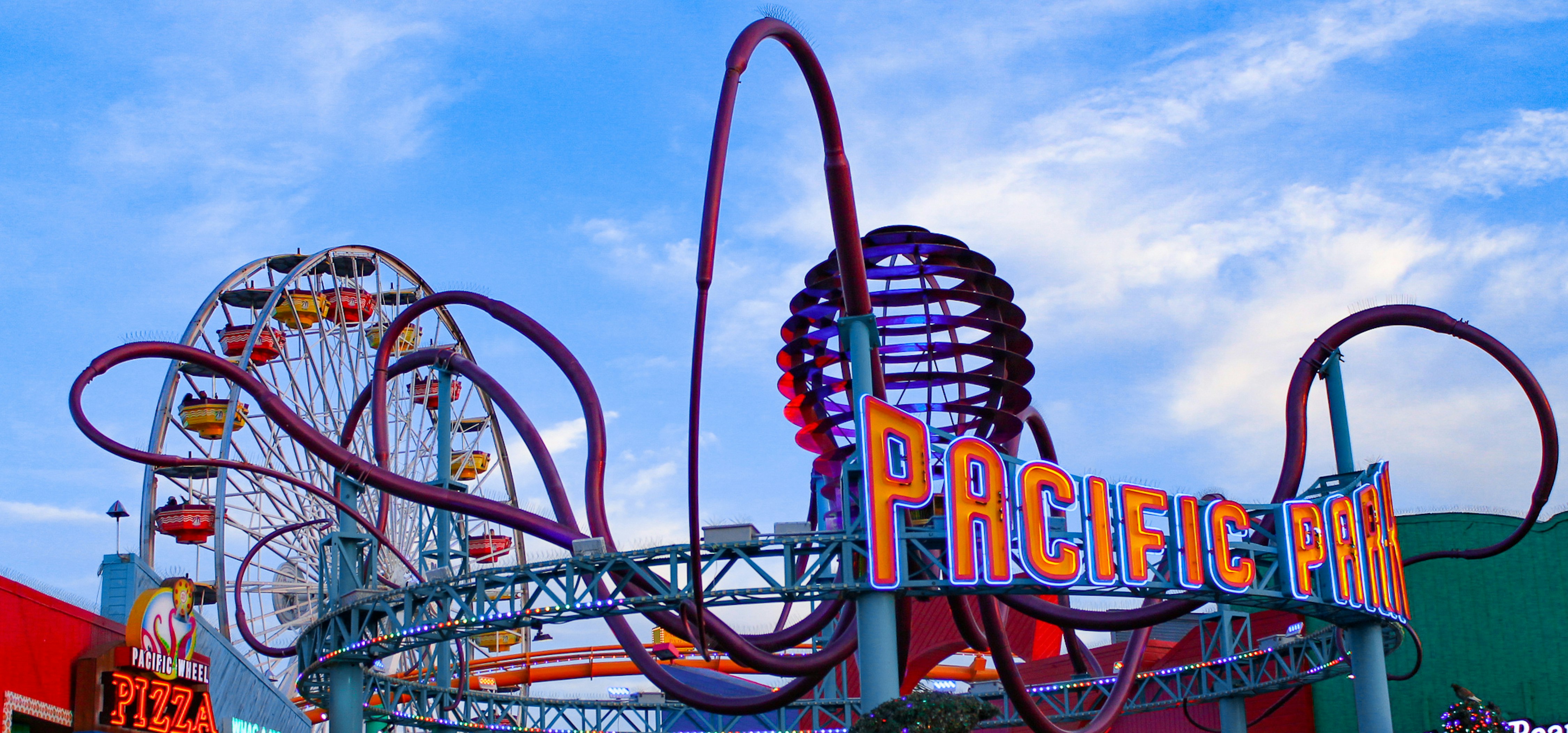 Neon Loops Over Pacific Park: A Colorful Carnival Skyline