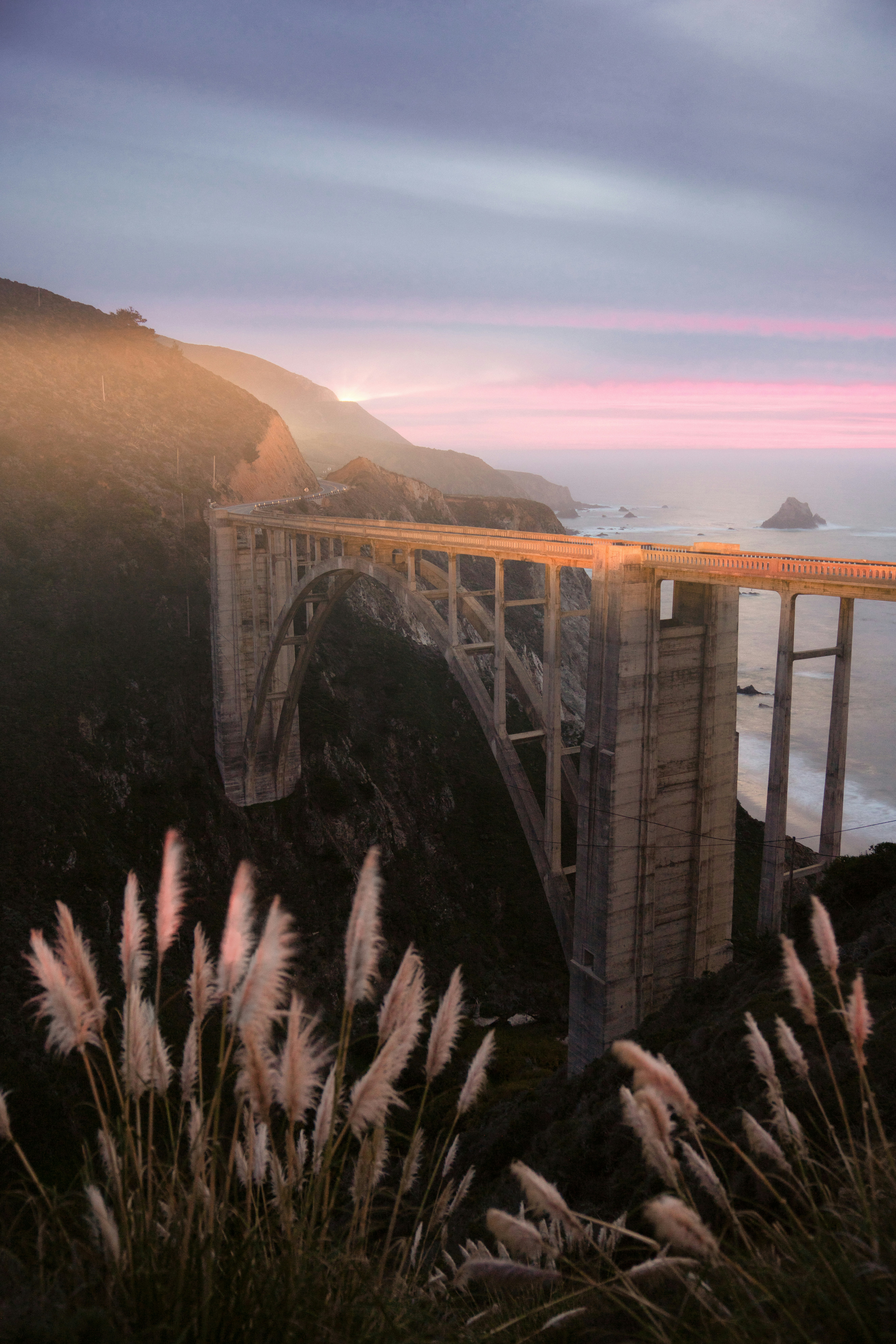 Pastel Sunset Drapes the Coastal Bridge Above Sea Cliffs