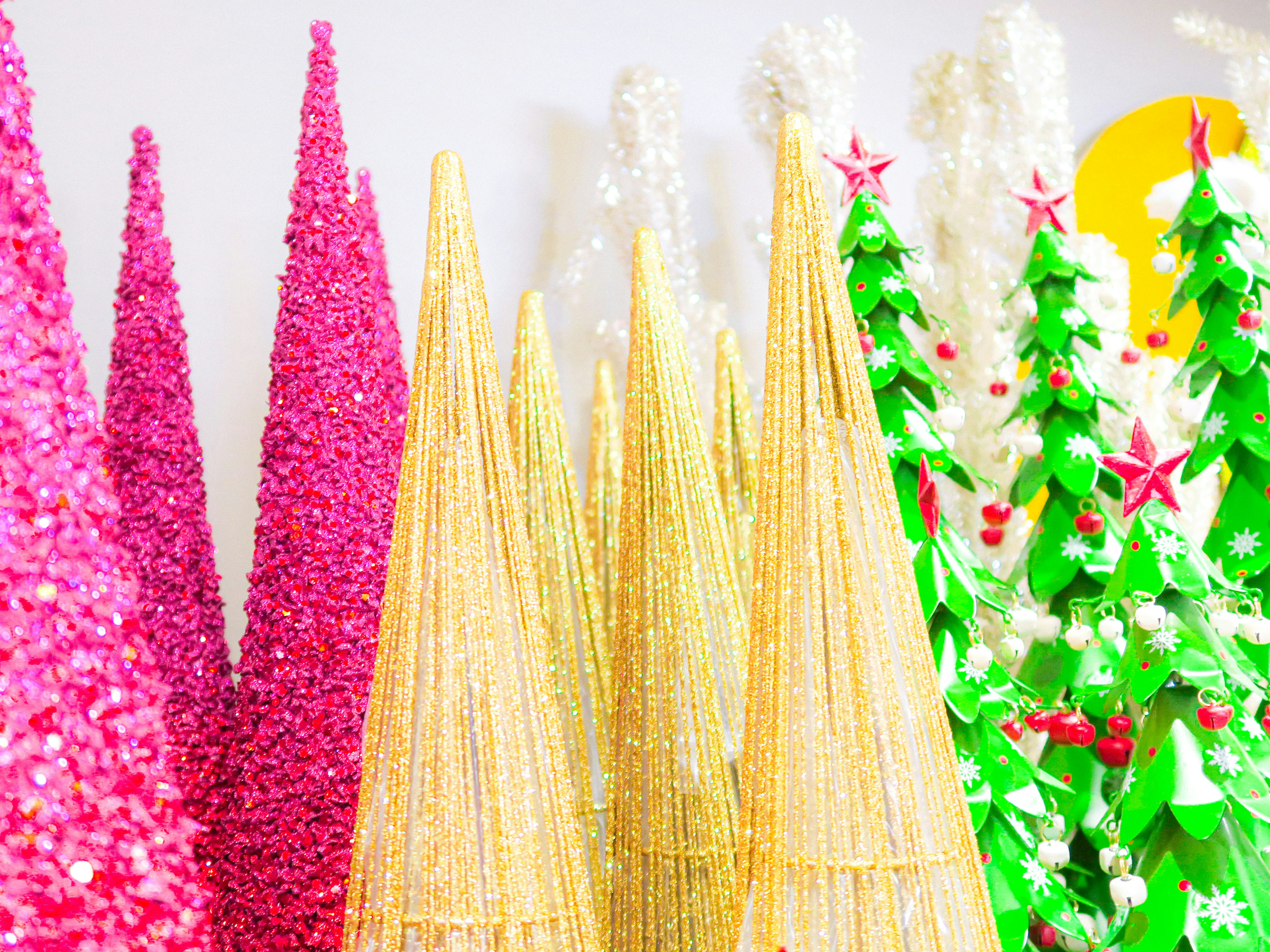 Glitter Row: Pink, Gold, and Emerald Christmas Cones in Studio Light