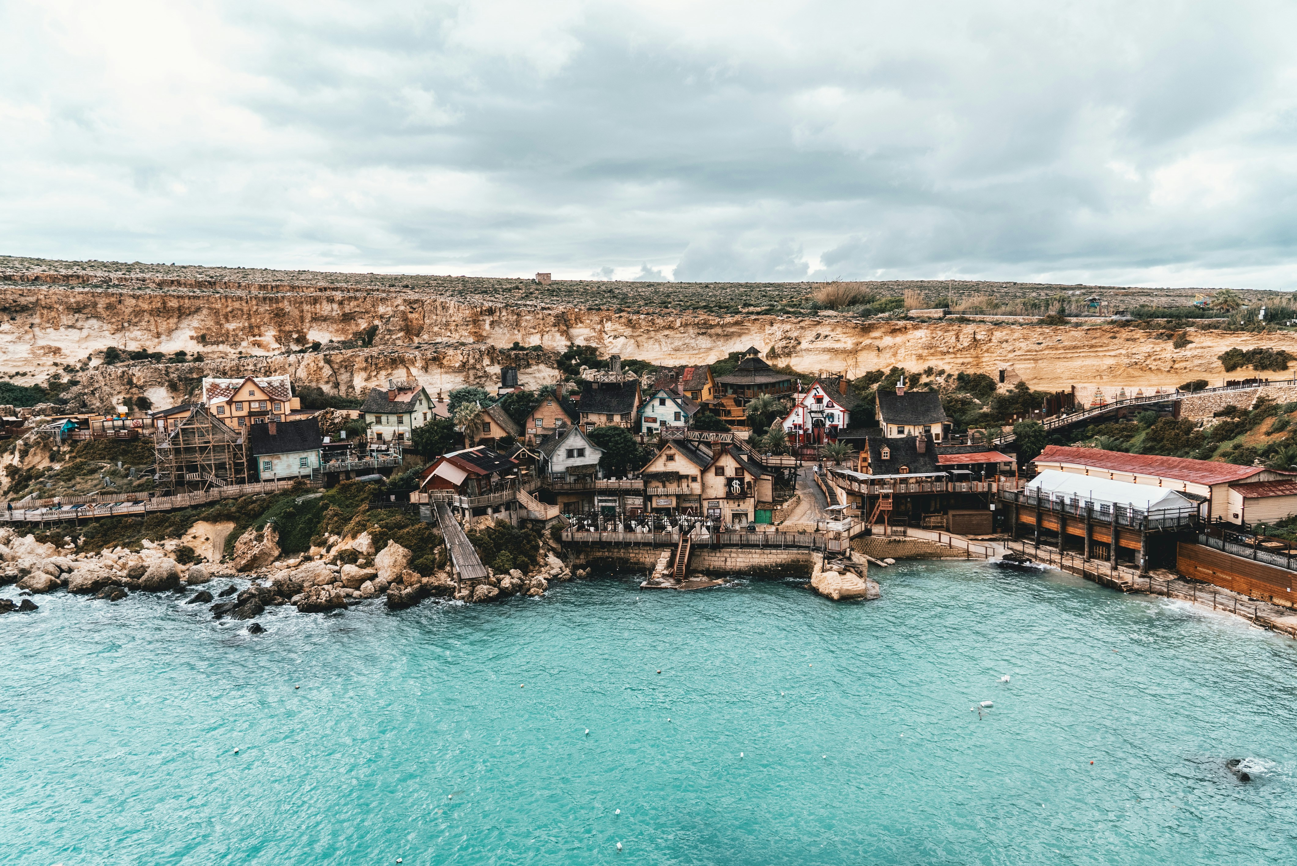 Cliffside Village Fringing a Turquoise Inlet