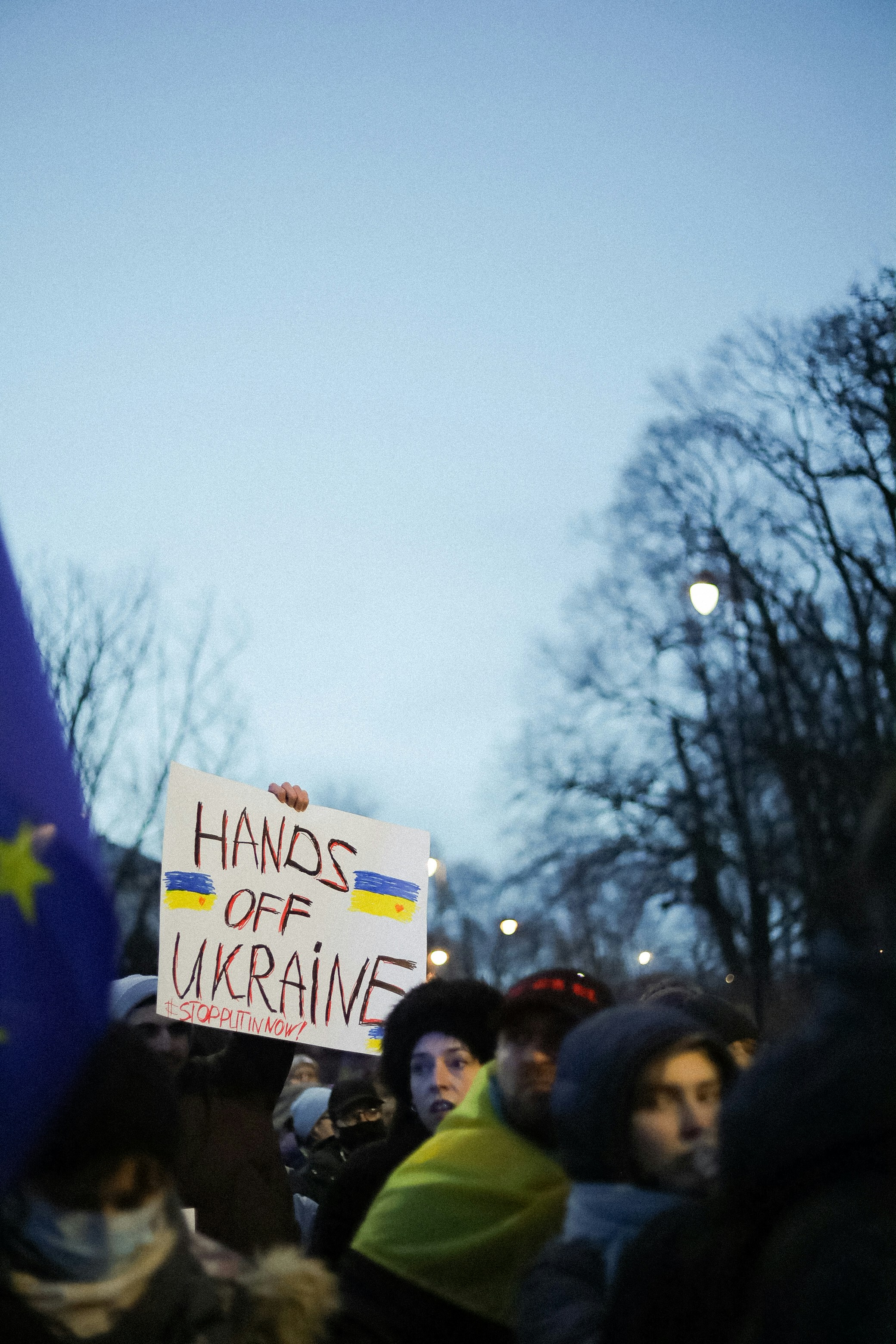 A group of people holding a sign photo – Free Current events Image on ...