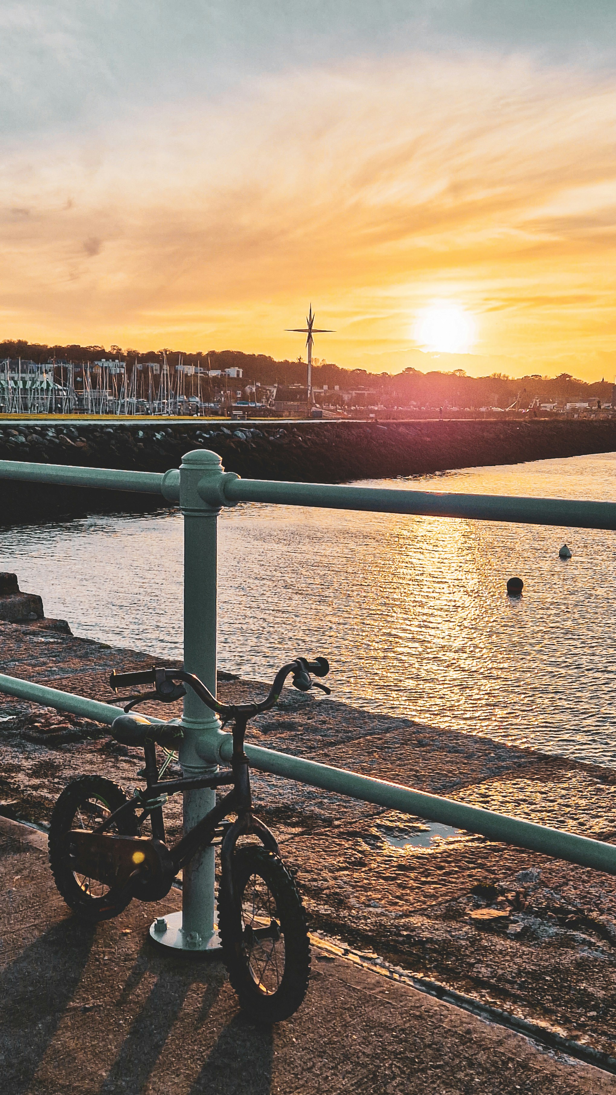 Sunset at the Harbor: A Quiet Bike Leaning by the Rail