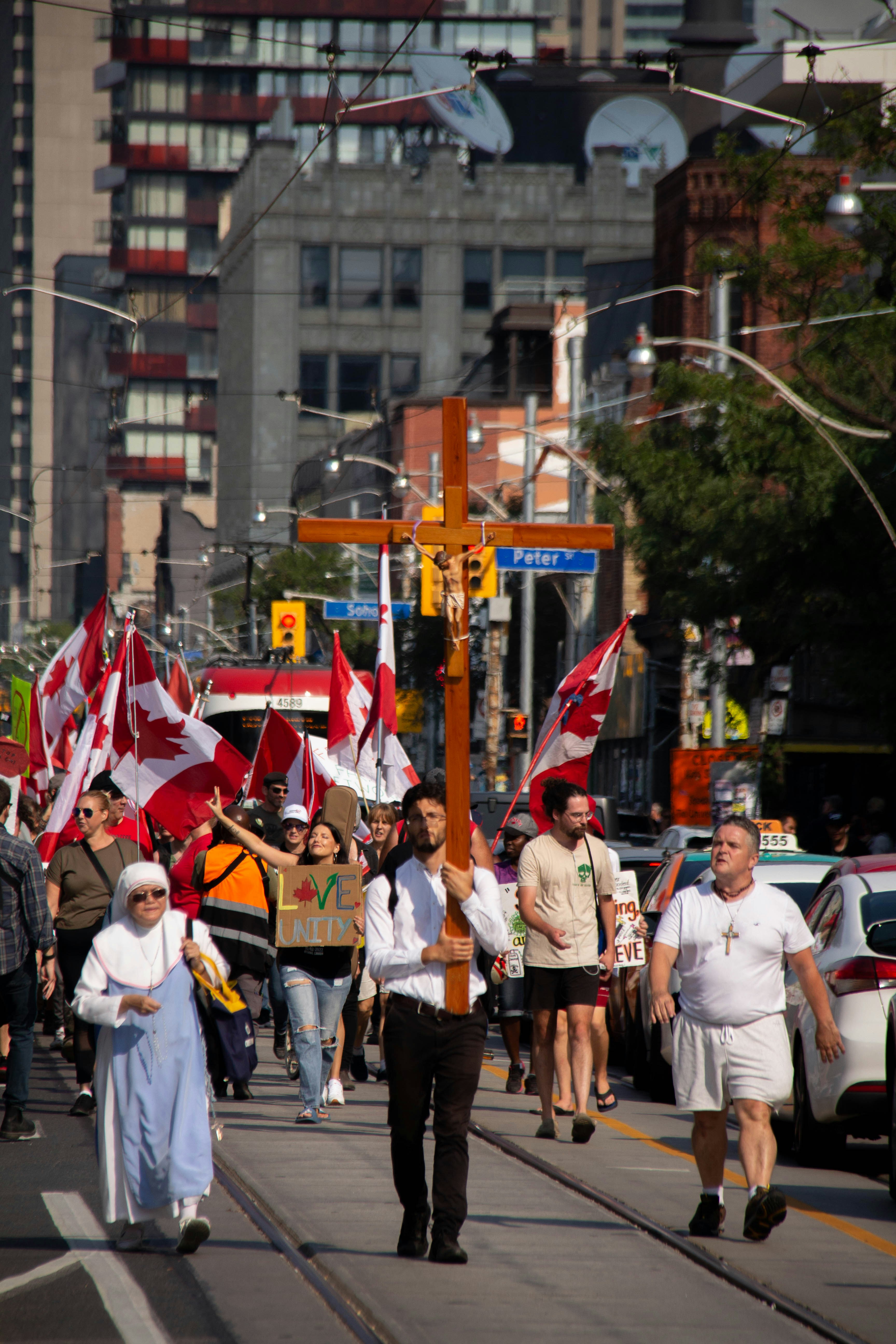 A group of people marching in the street photo – Free Covid Image on ...