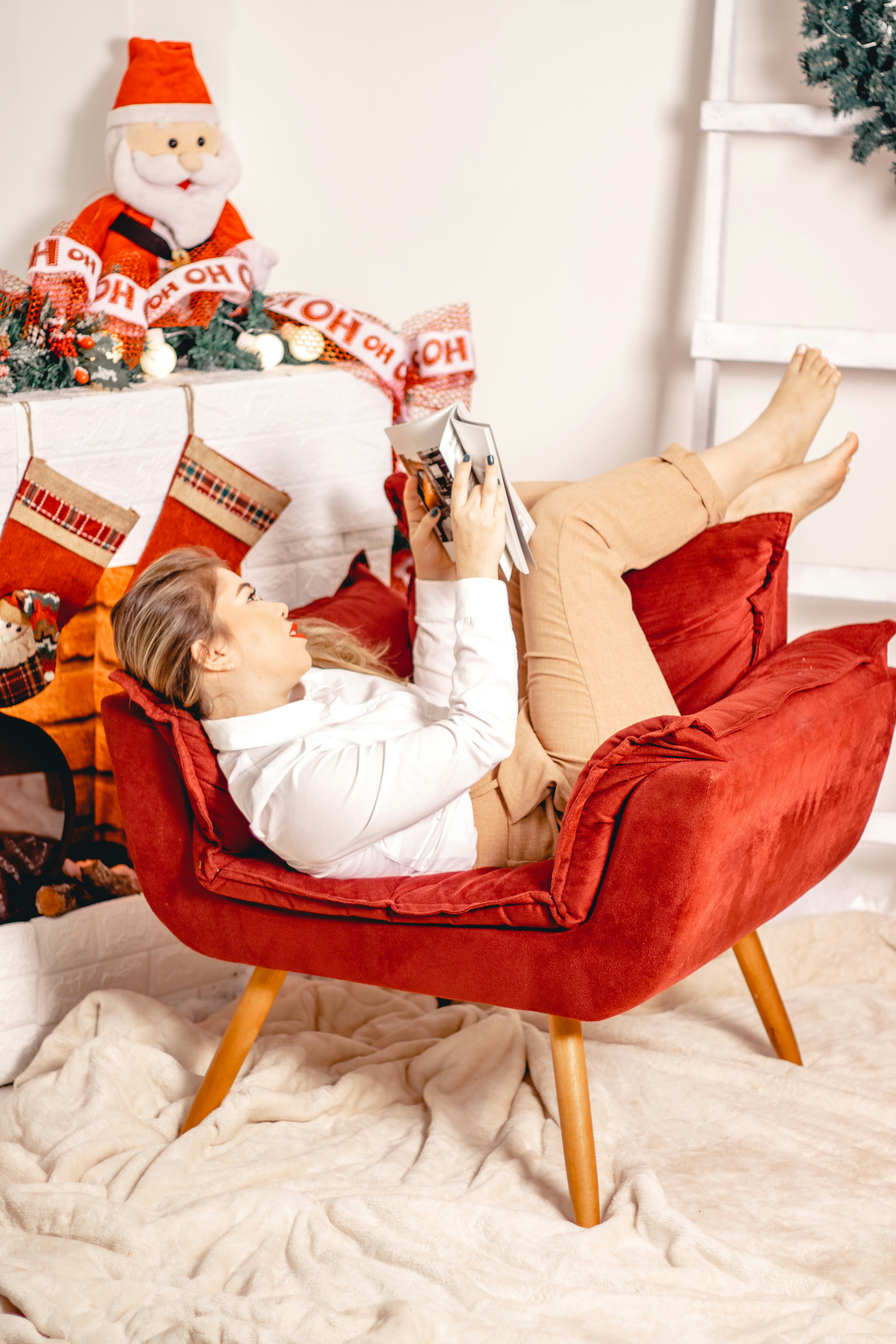 Cozy Holiday Recline: A Reader's Moment in Red Velvet Comfort