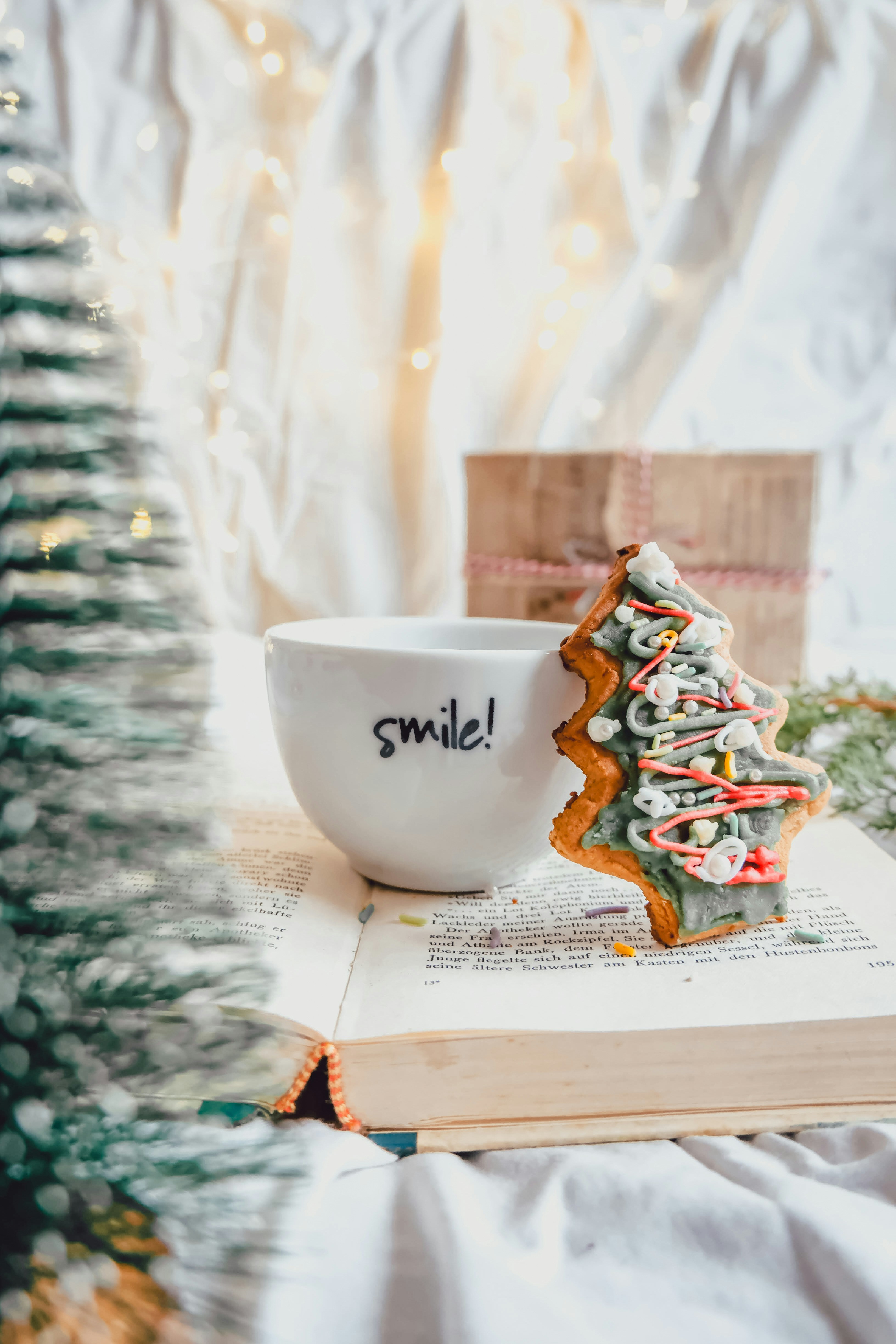 Cup of Cheer: A Merry Cookie Moment with a Christmas Tree and Cardboard Gift