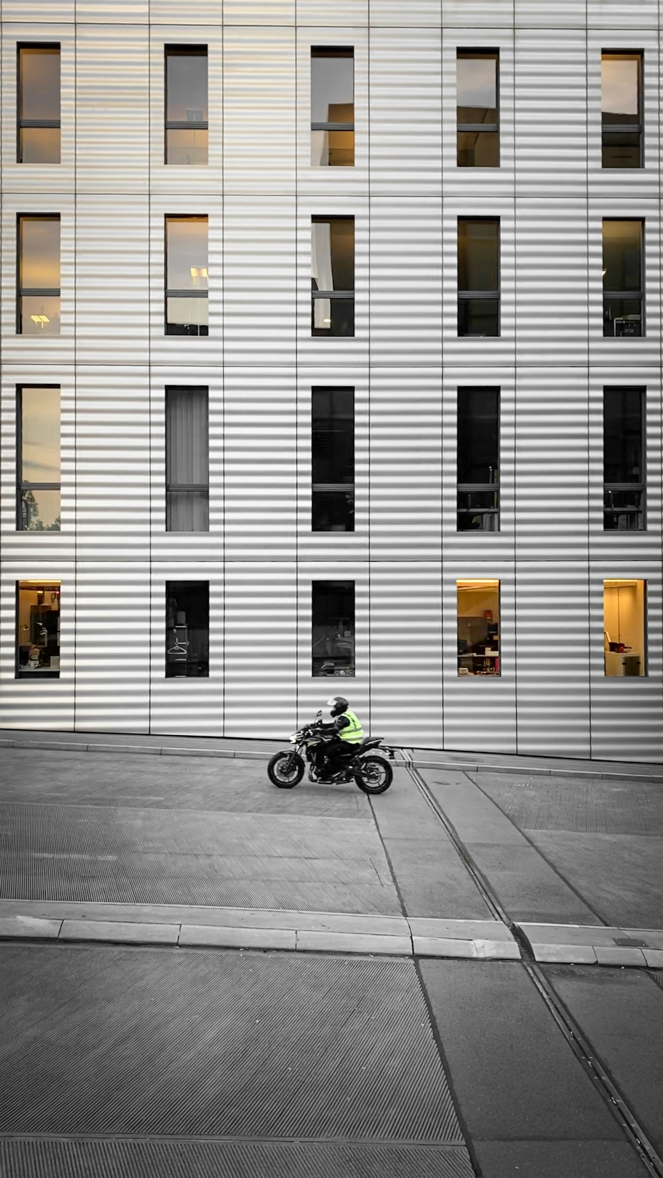 Neon Rider Conquers the Grid: Motorcycle Against a Modern Facade