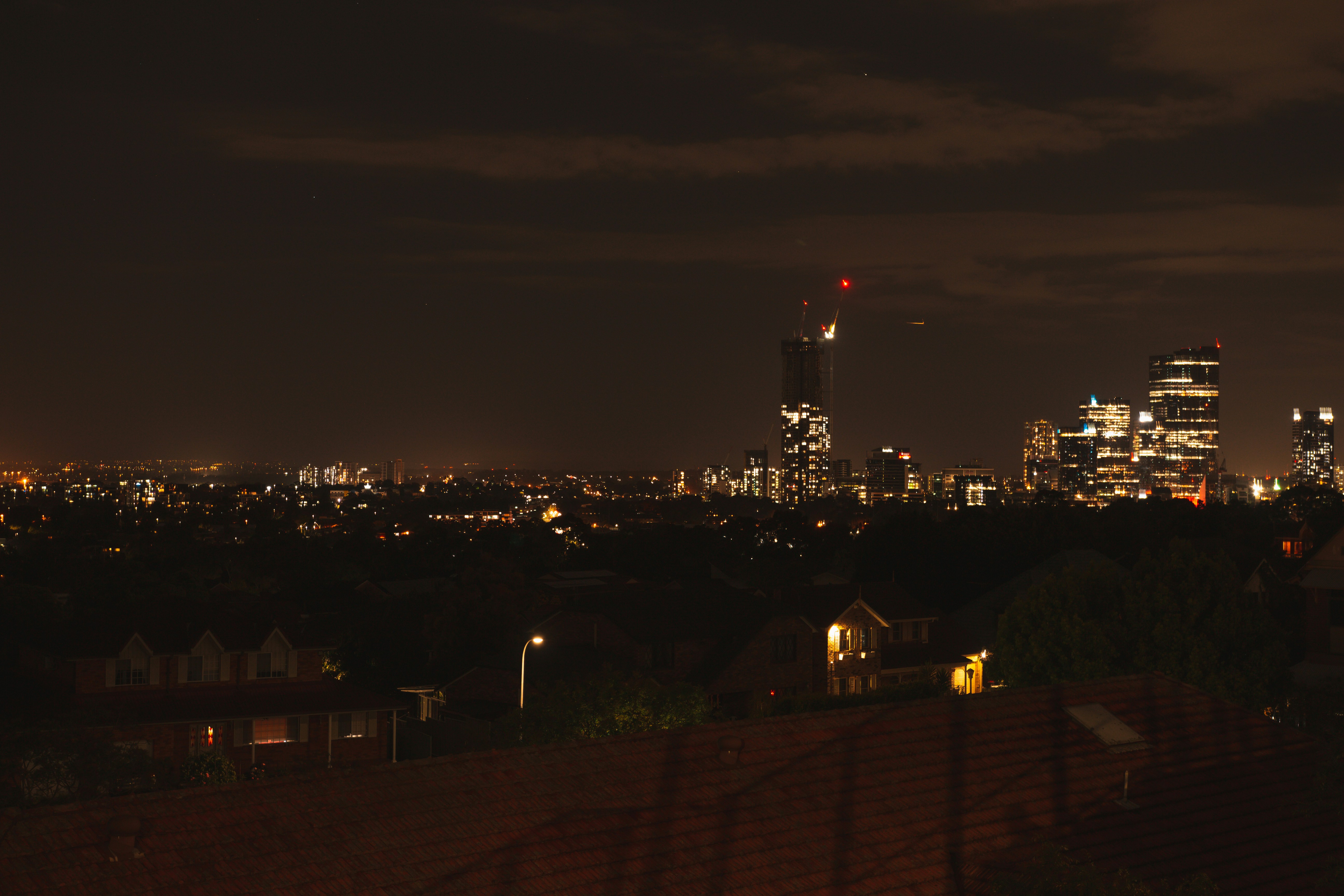 Beacon Above Quiet Cityscape: Night Edge of Suburbia