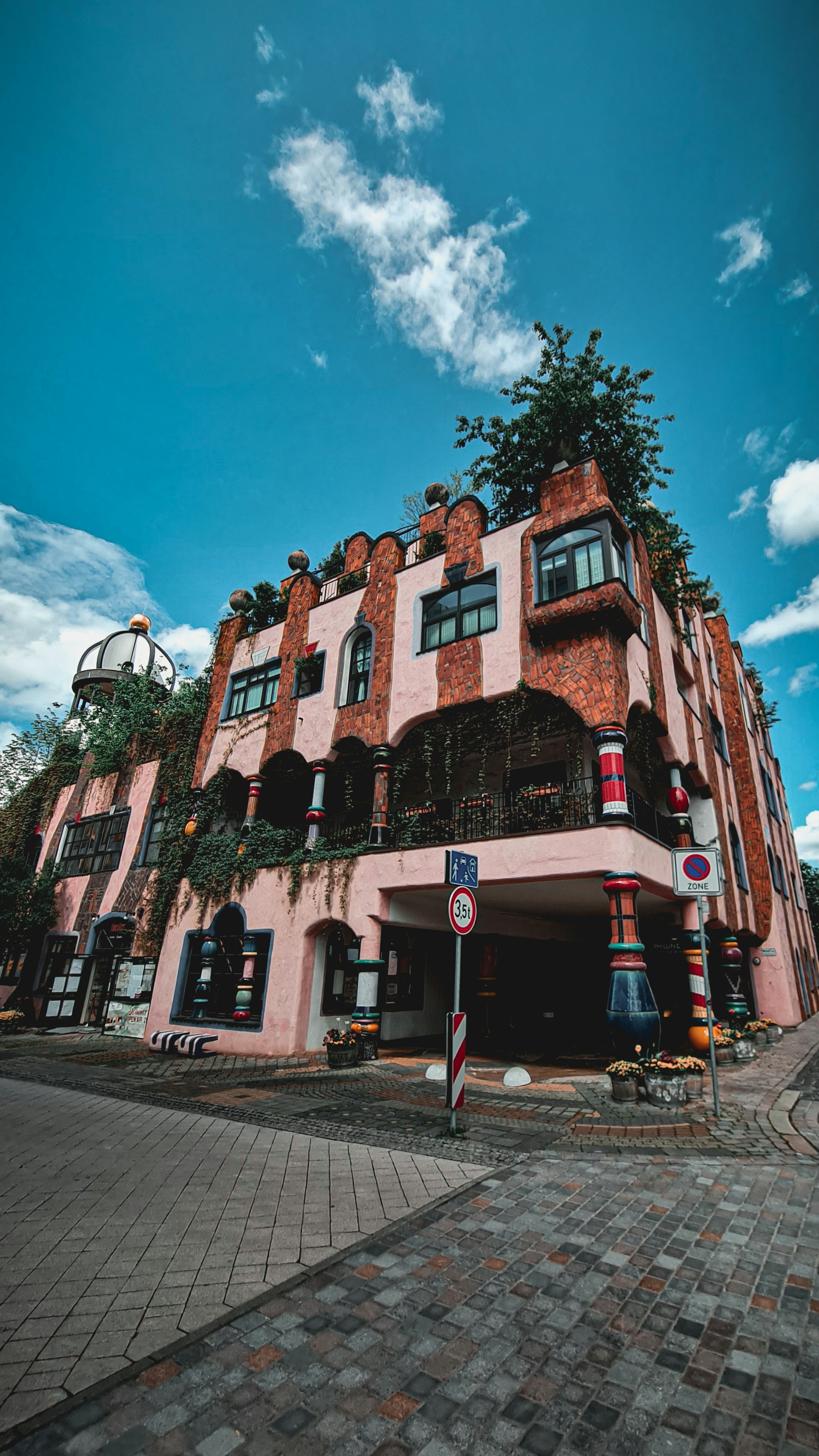 Whimsical Pink Facade Rising Over Cobbled Street