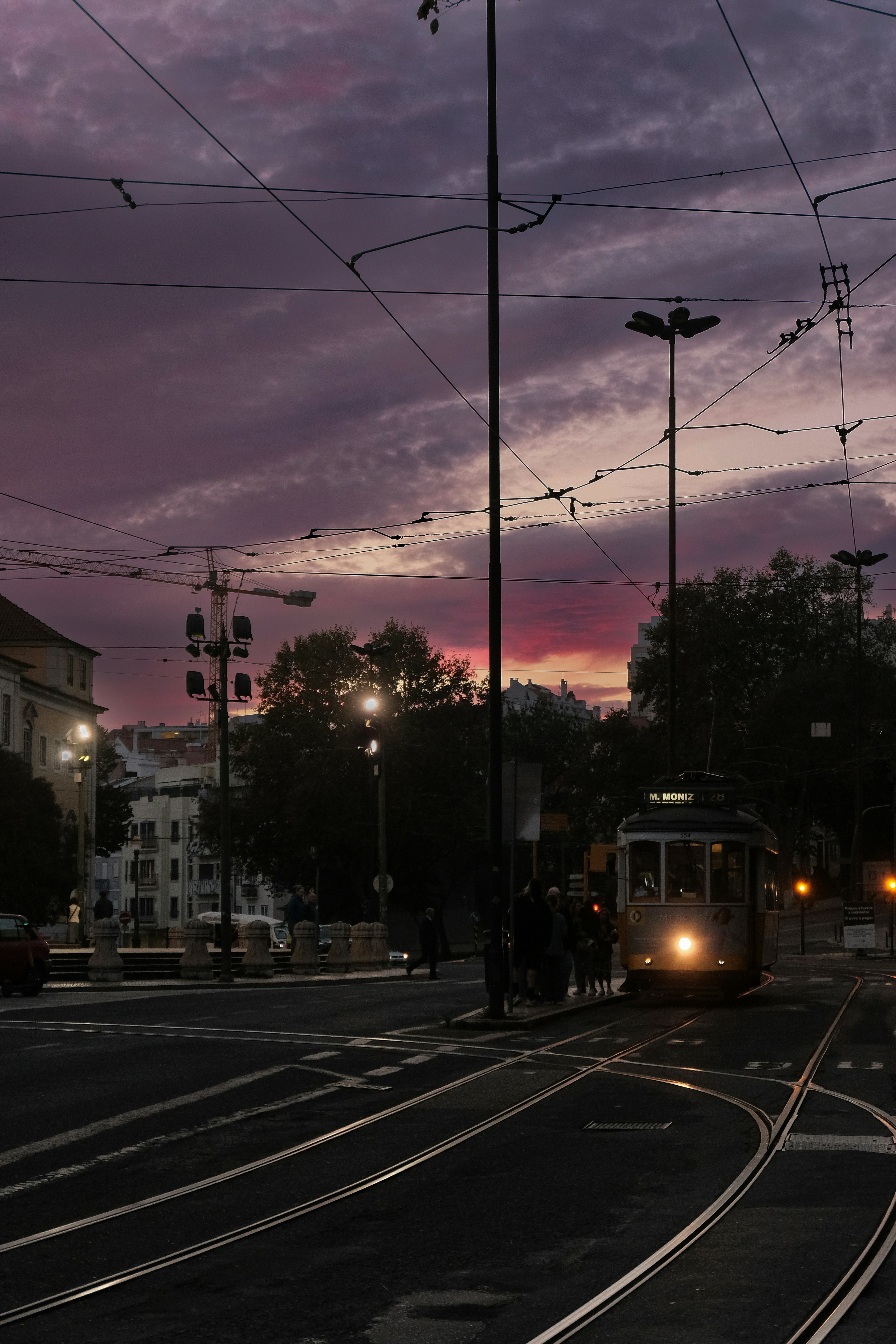 Dusk Tram Woven Through a Web of Wires