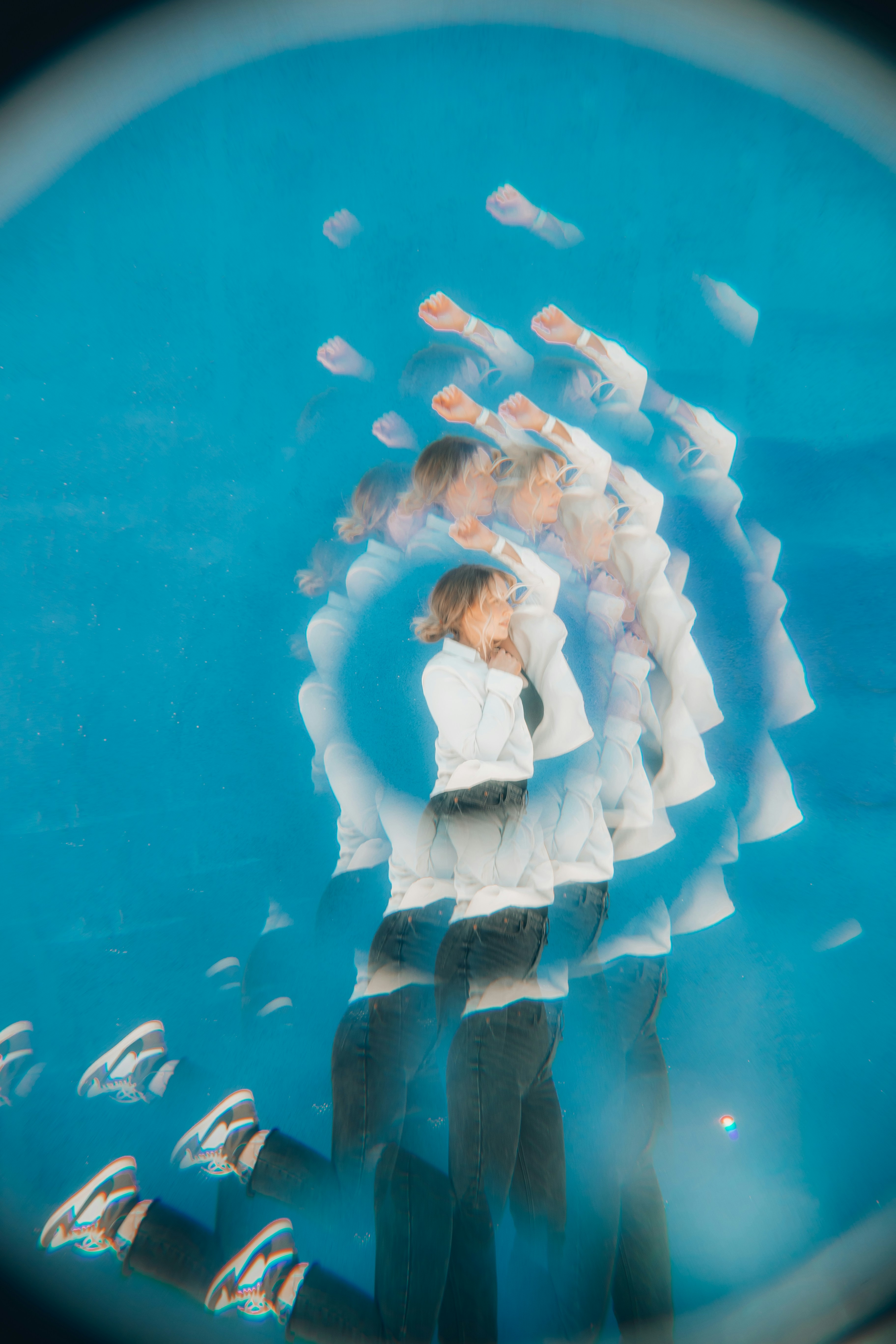 A dynamic portrayal of a person in motion, captured with a swirling effect against a vibrant blue backdrop.