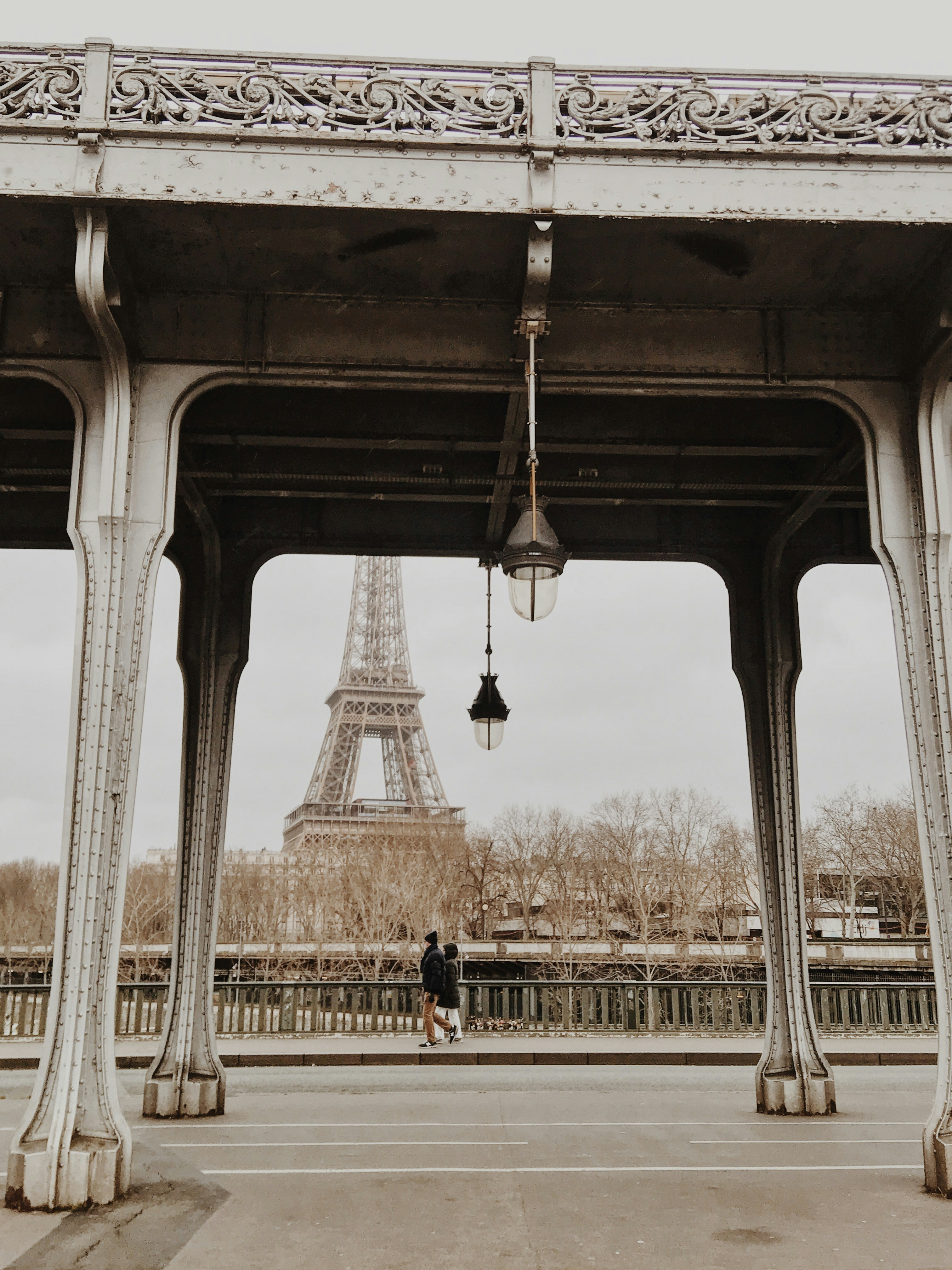 A person walking under a bridge photo – Free Paris Image on Unsplash